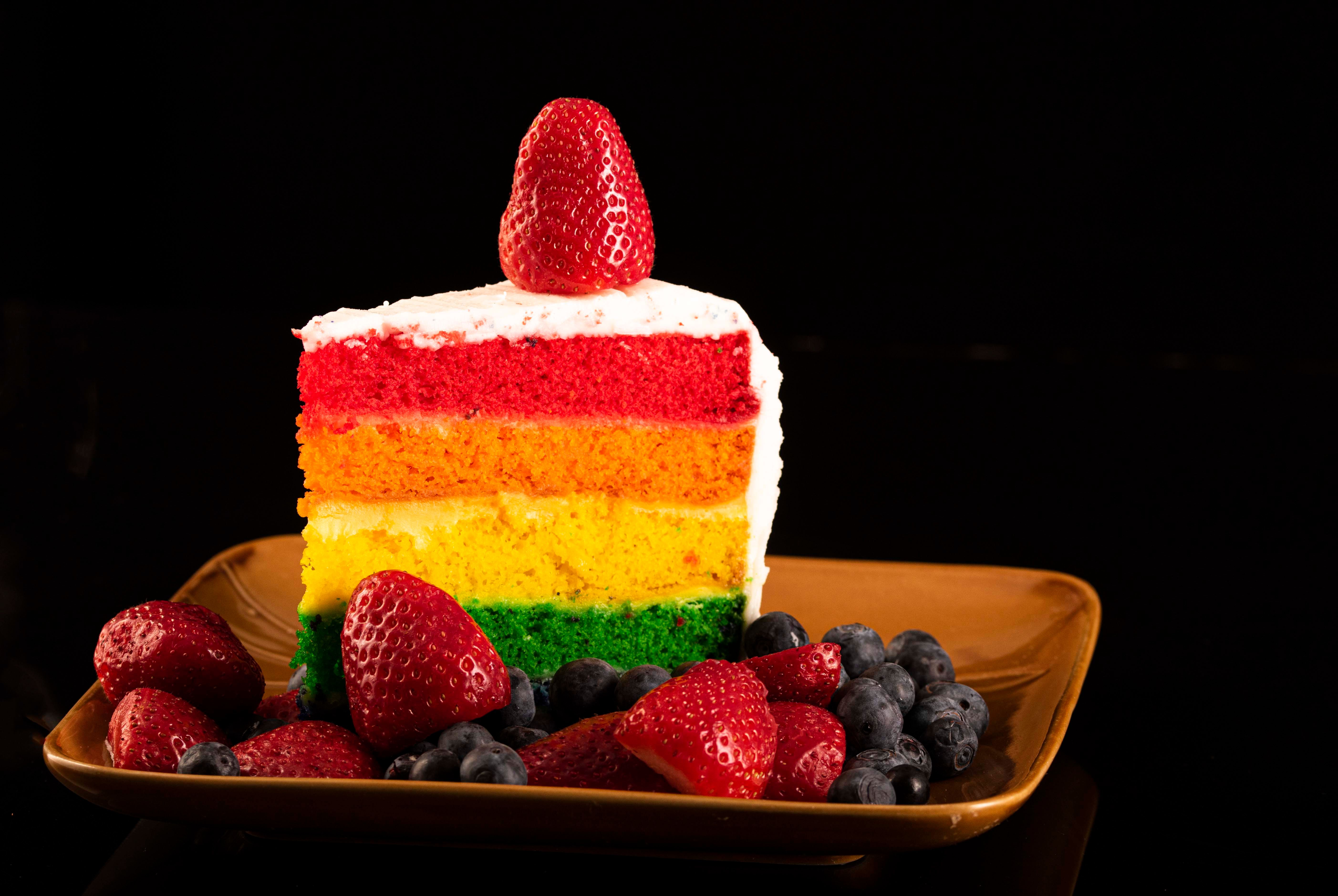 Colorful Rainbow Cake Slice with Berries · Free Stock Photo