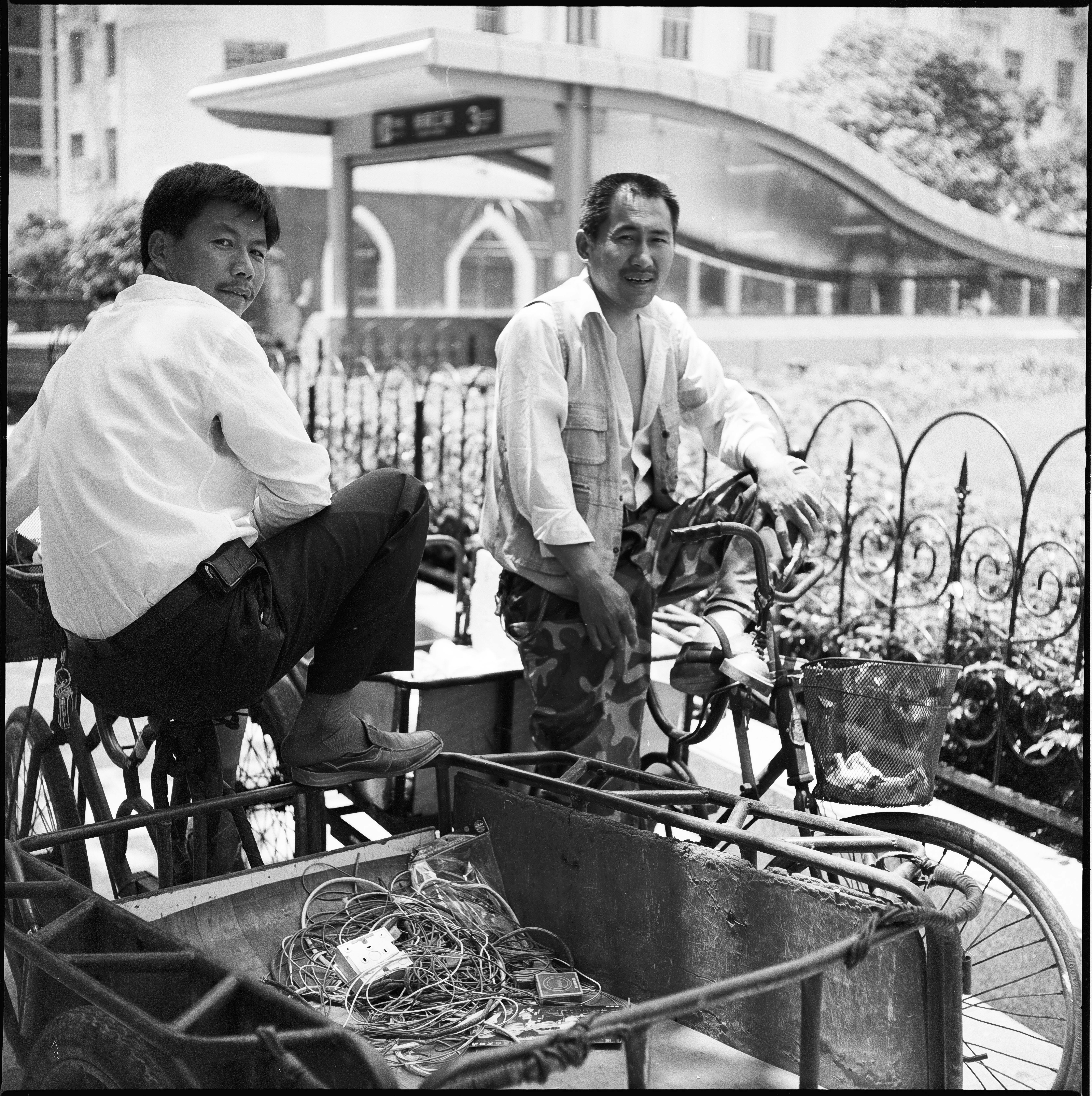 Two Male Cyclists Talking on the Street · Free Stock Photo