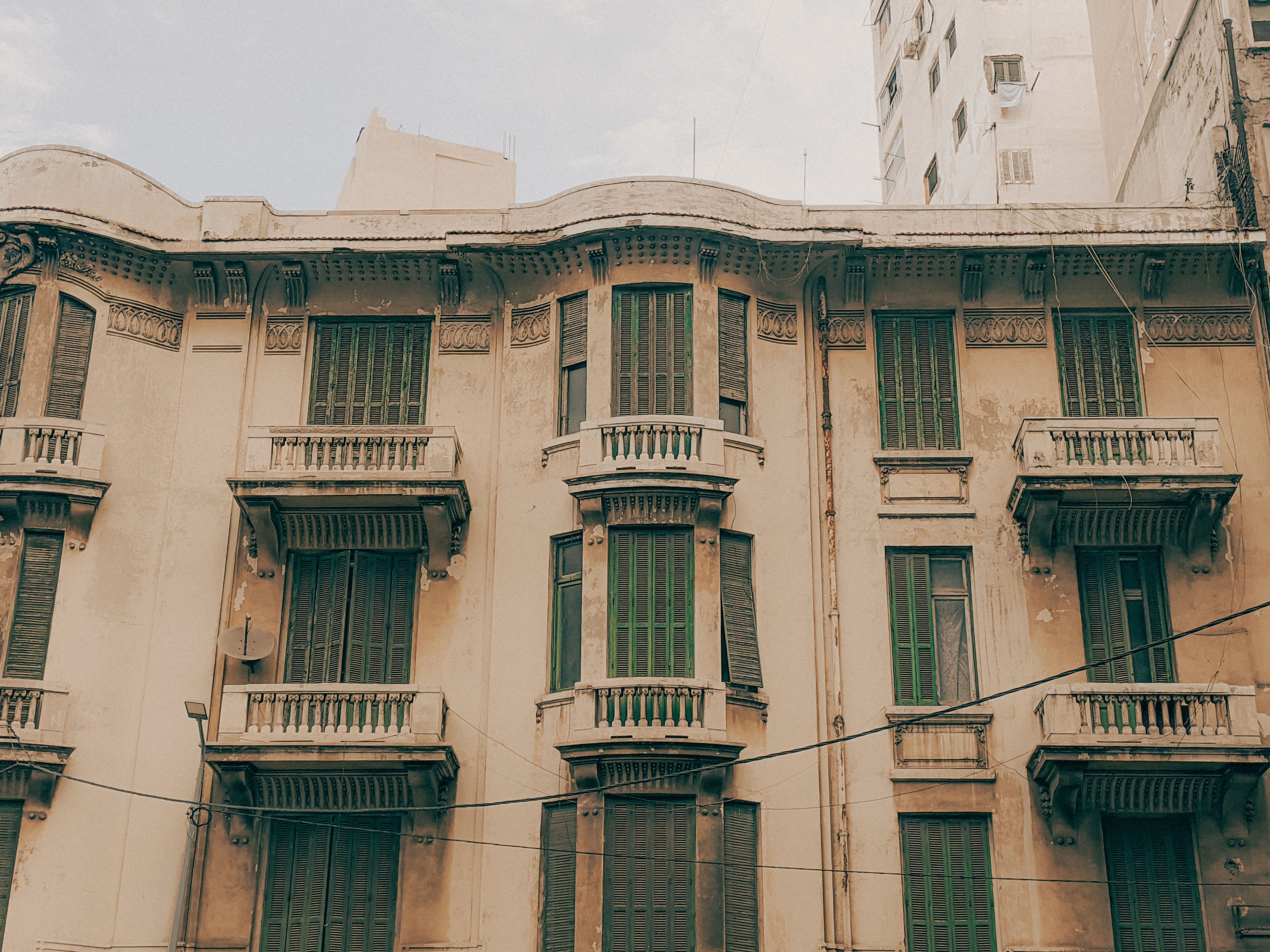 Historic Building Facade with Green Accents · Free Stock Photo