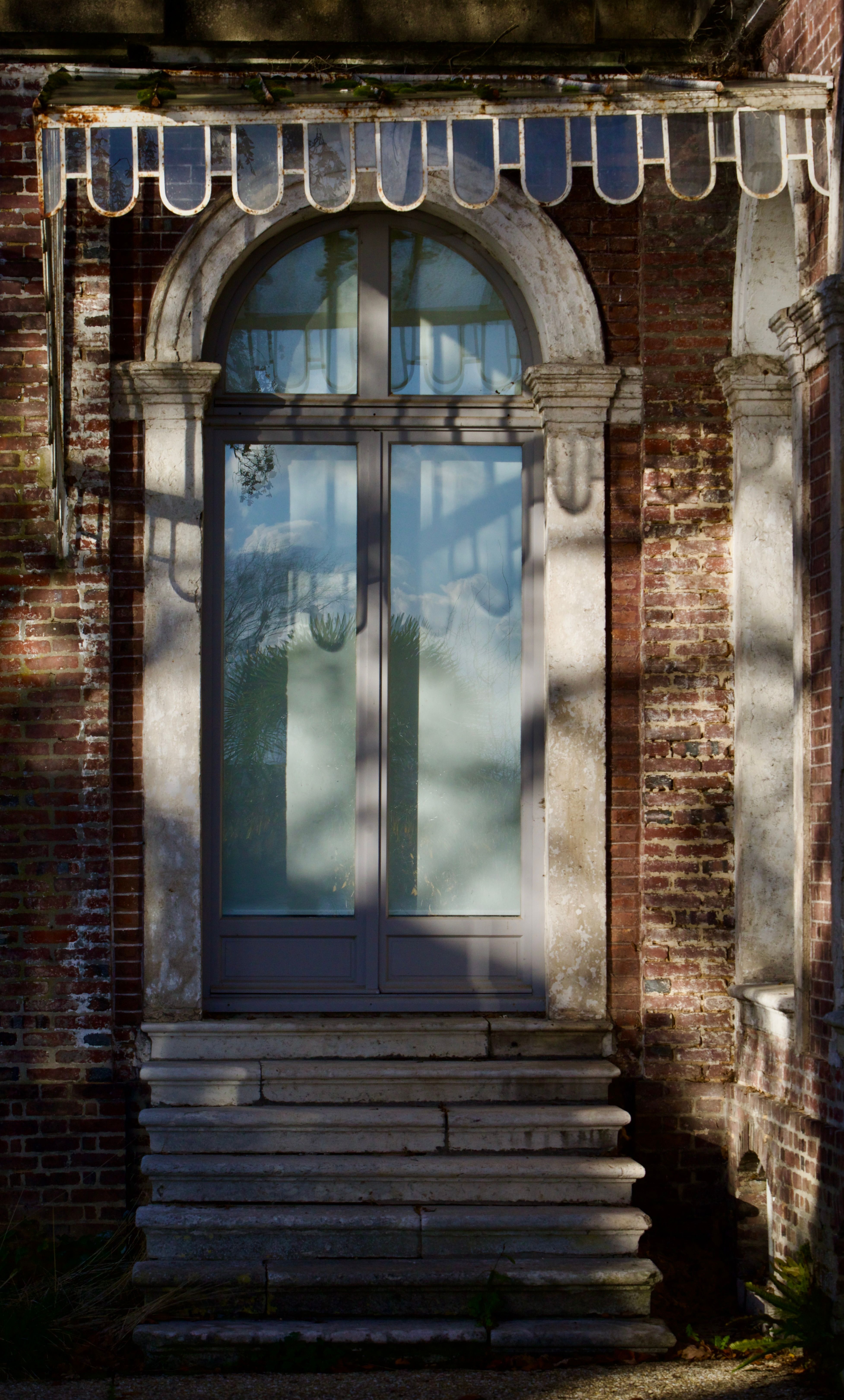 Ornate Tombstone Behind Iron Gate in Cemetery · Free Stock Photo