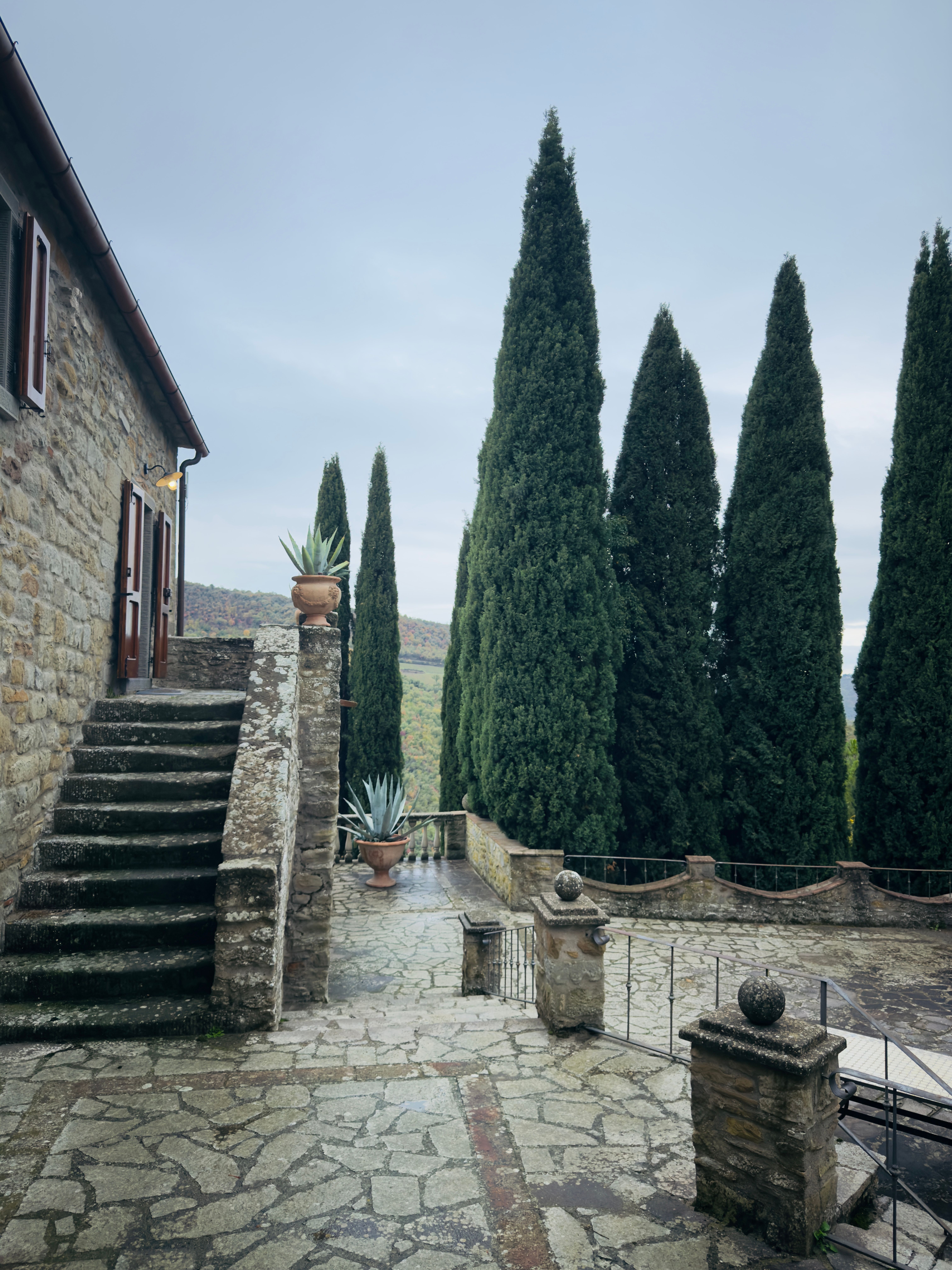 Charming Italian Villa Courtyard with Cypress Trees · Free Stock Photo