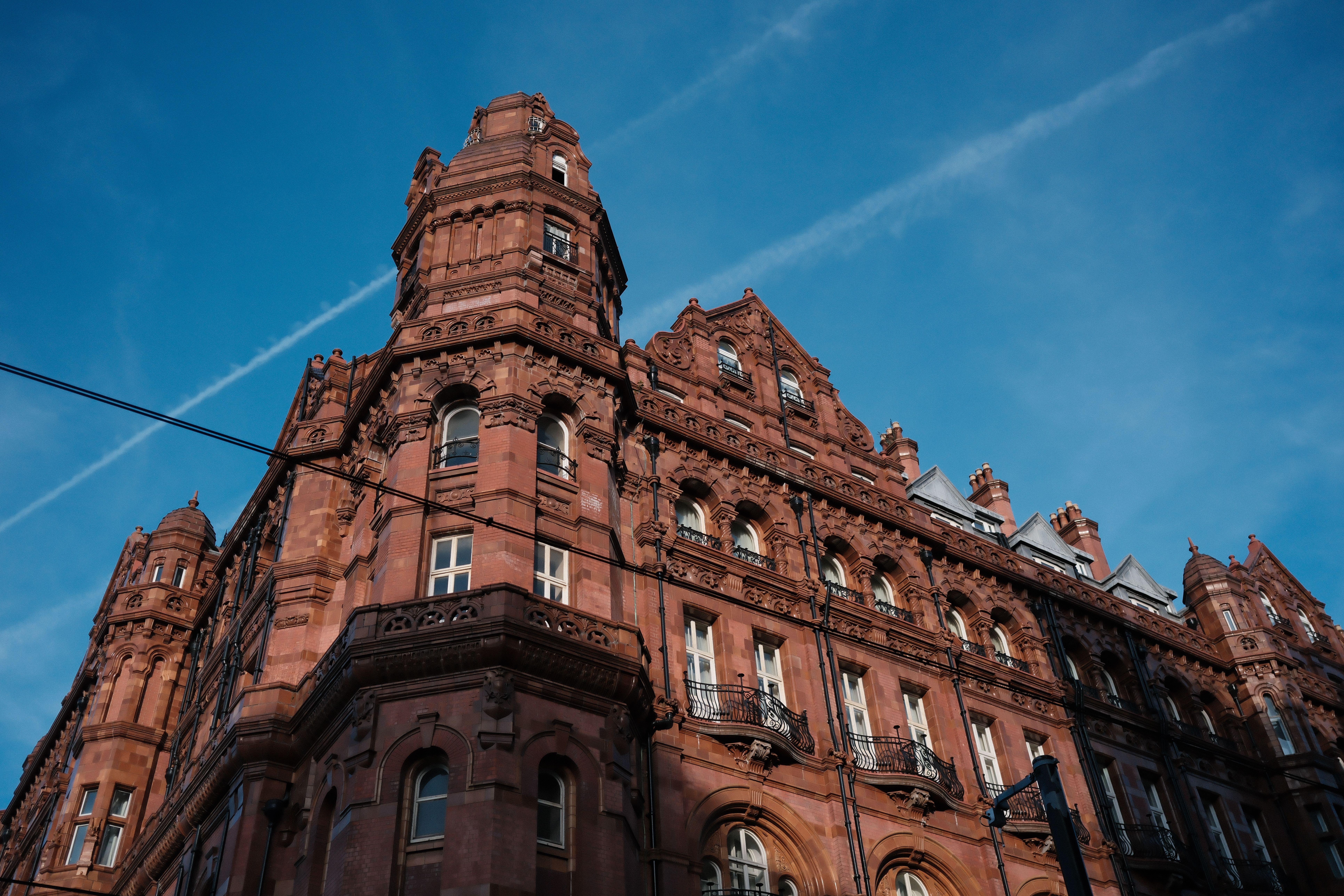 Victorian Red Brick Building Against Blue Sky · Free Stock Photo