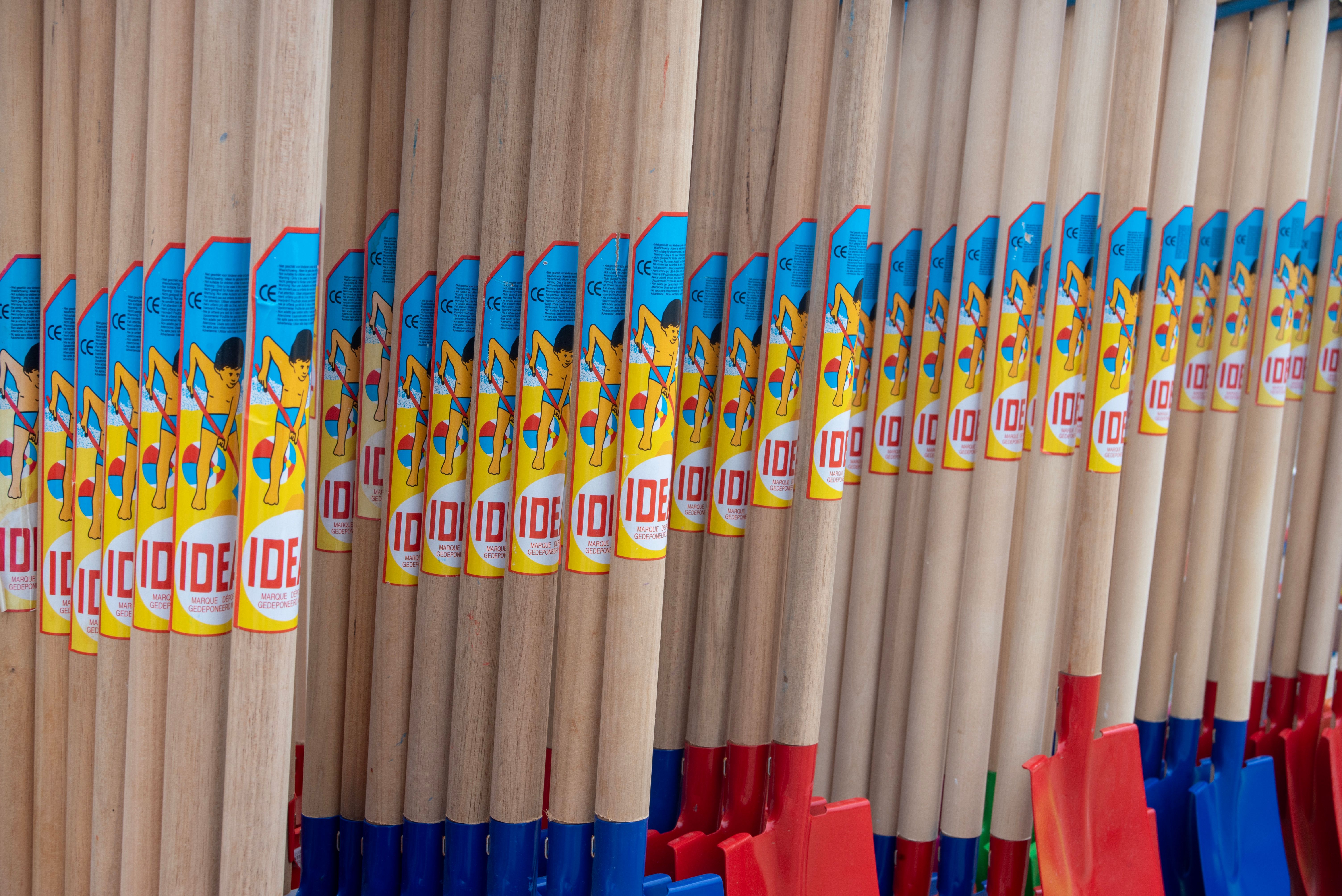 Colorful Shovel Handles Lined Up in Store · Free Stock Photo