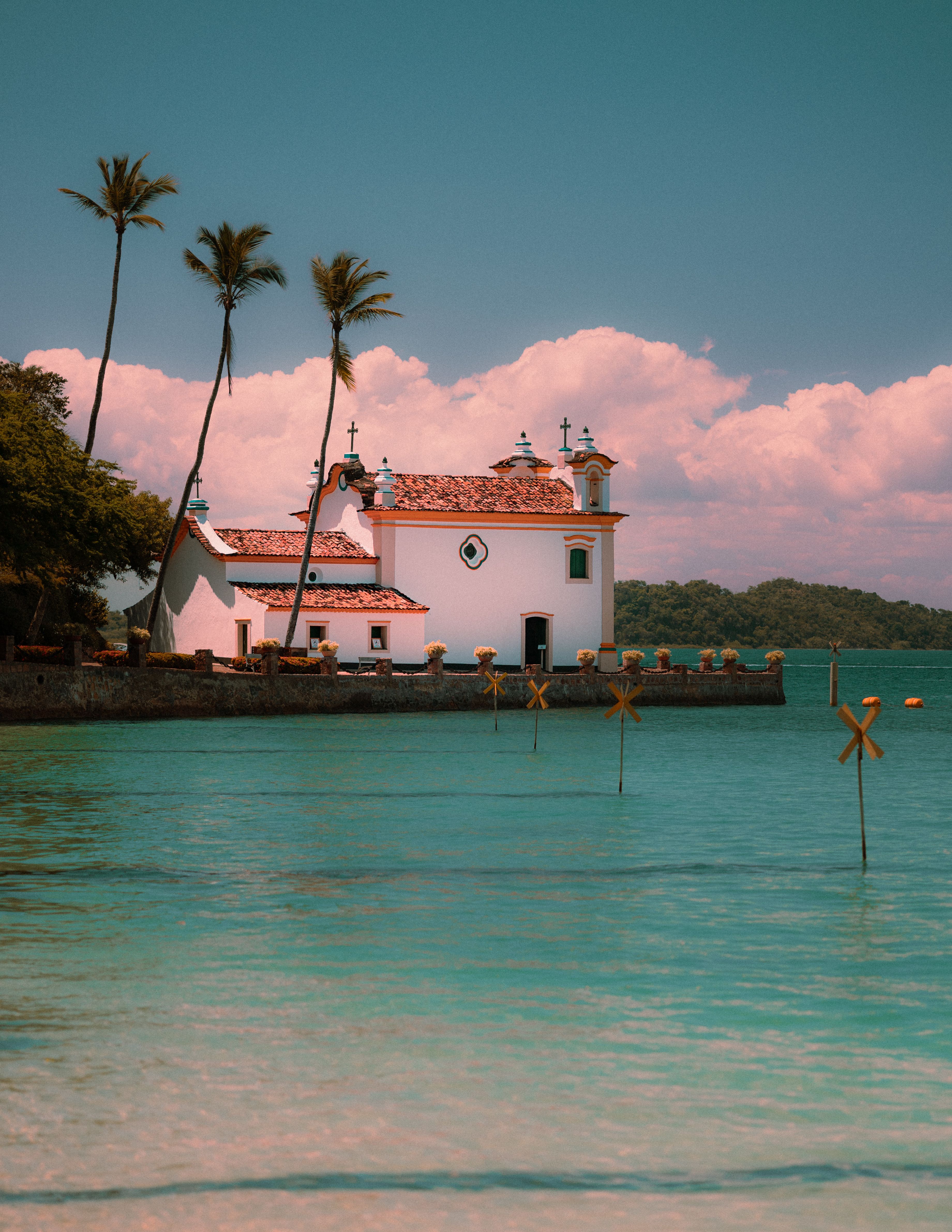 Scenic View of Coastal Church with Palm Trees · Free Stock Photo