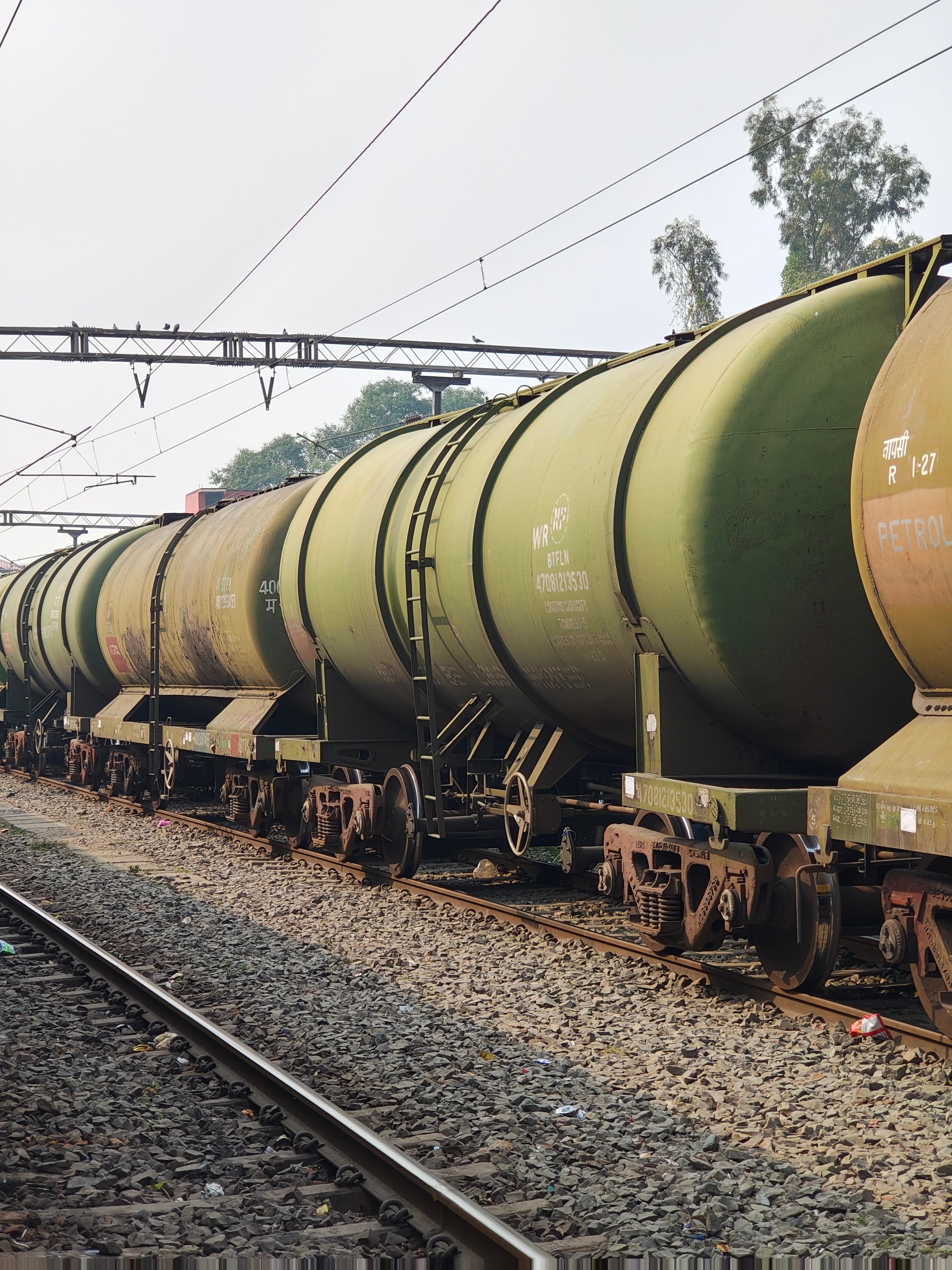 Long Freight Train with Fuel Tankers on Tracks · Free Stock Photo