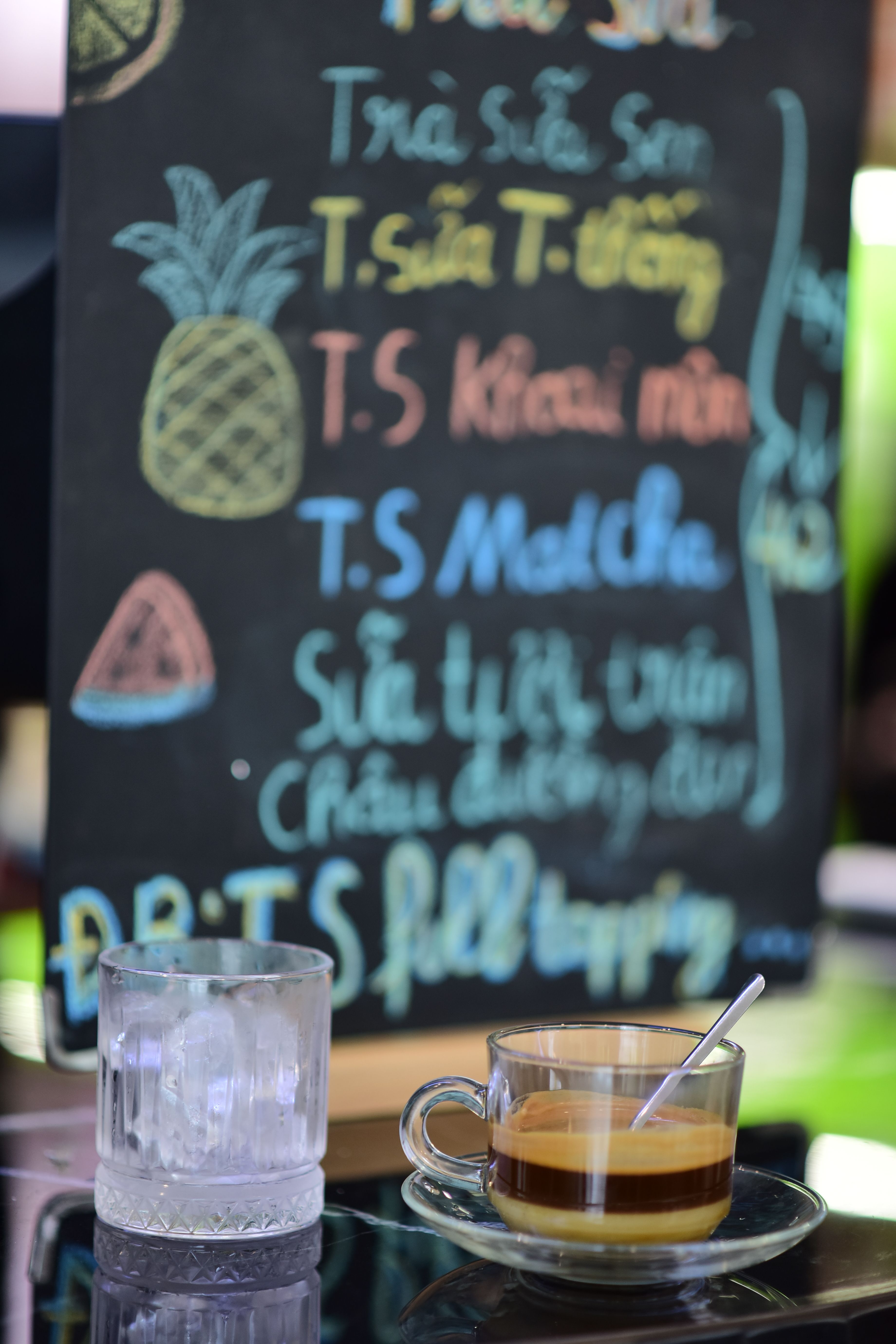 Coffee and Chalkboard Signs in Vietnamese Cafe · Free Stock Photo