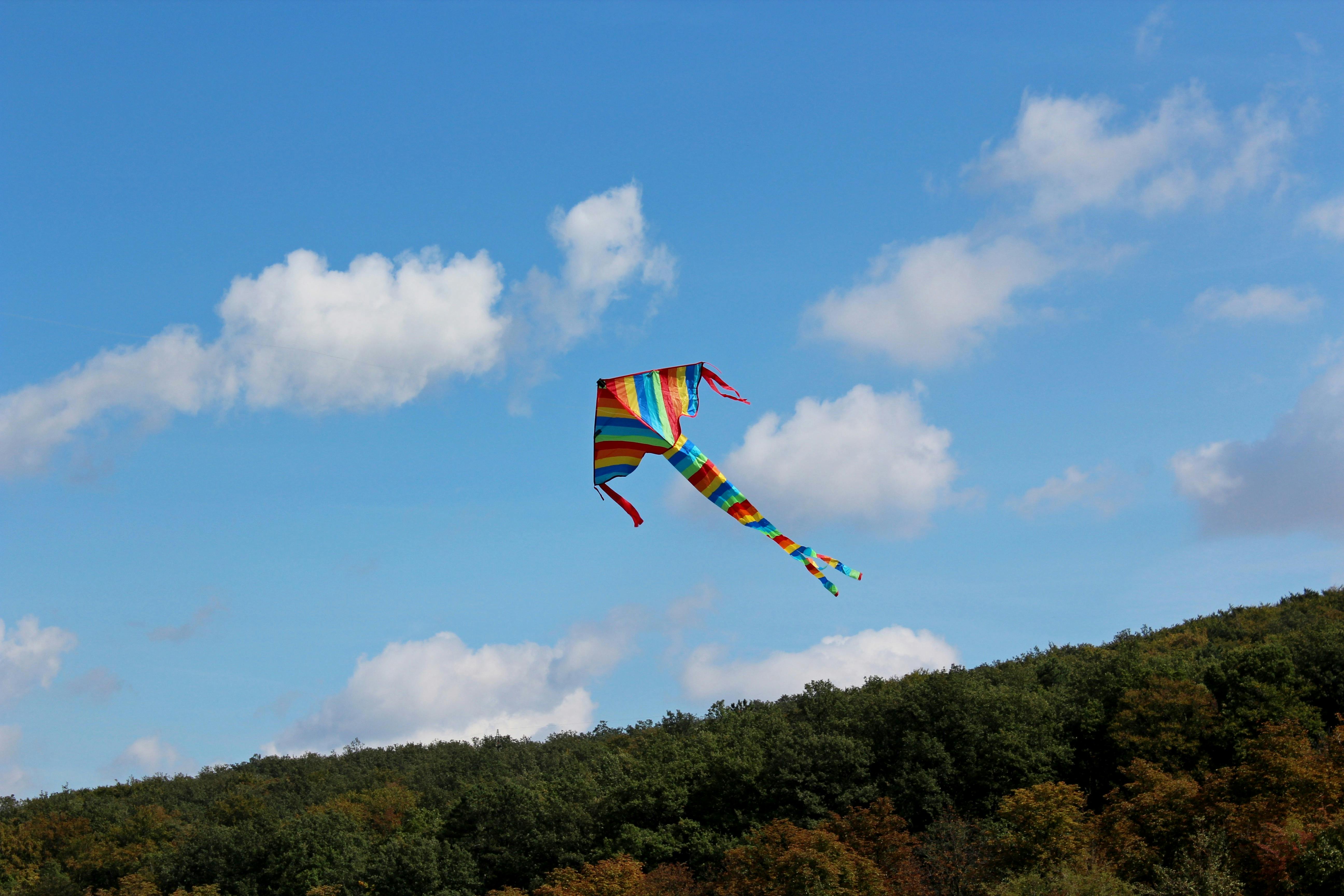Colorful Kite Flying in Clear Blue Sky · Free Stock Photo