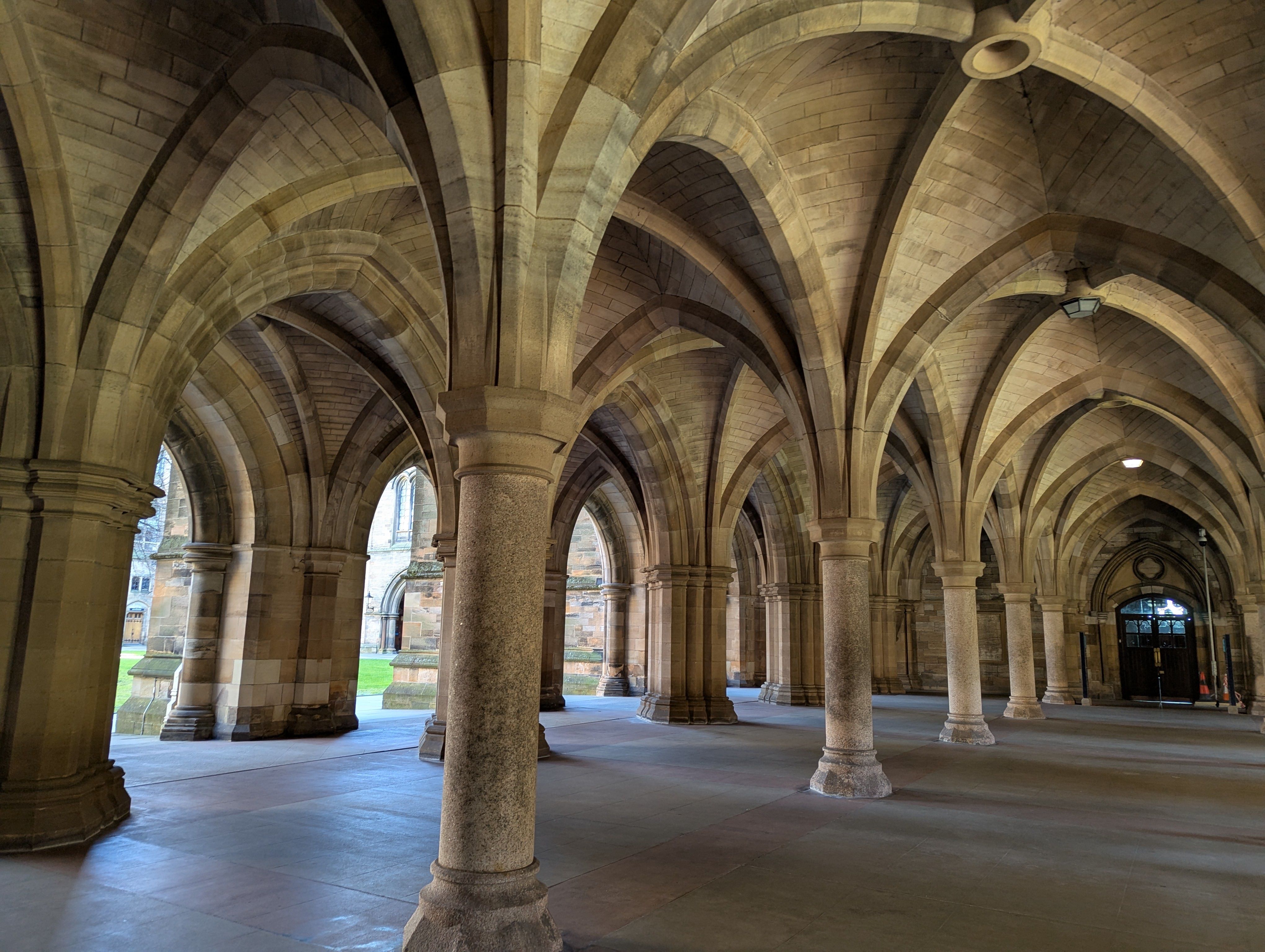 Gothic Arches of Historic Stone Corridor · Free Stock Photo