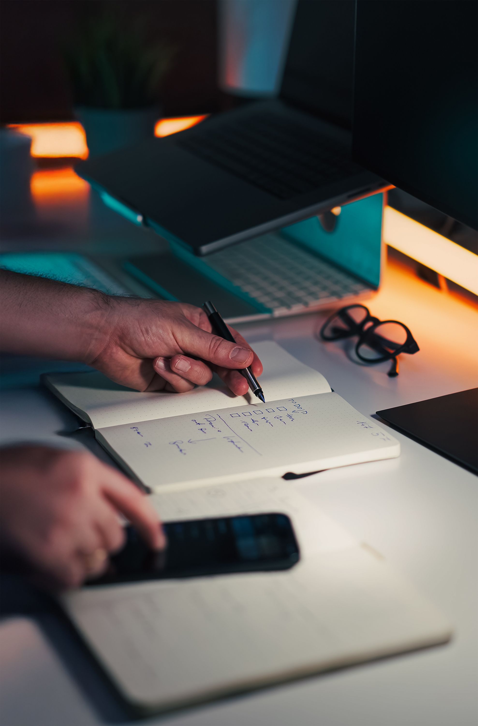 Hands Writing in Notebook on Modern Office Desk · Free Stock Photo