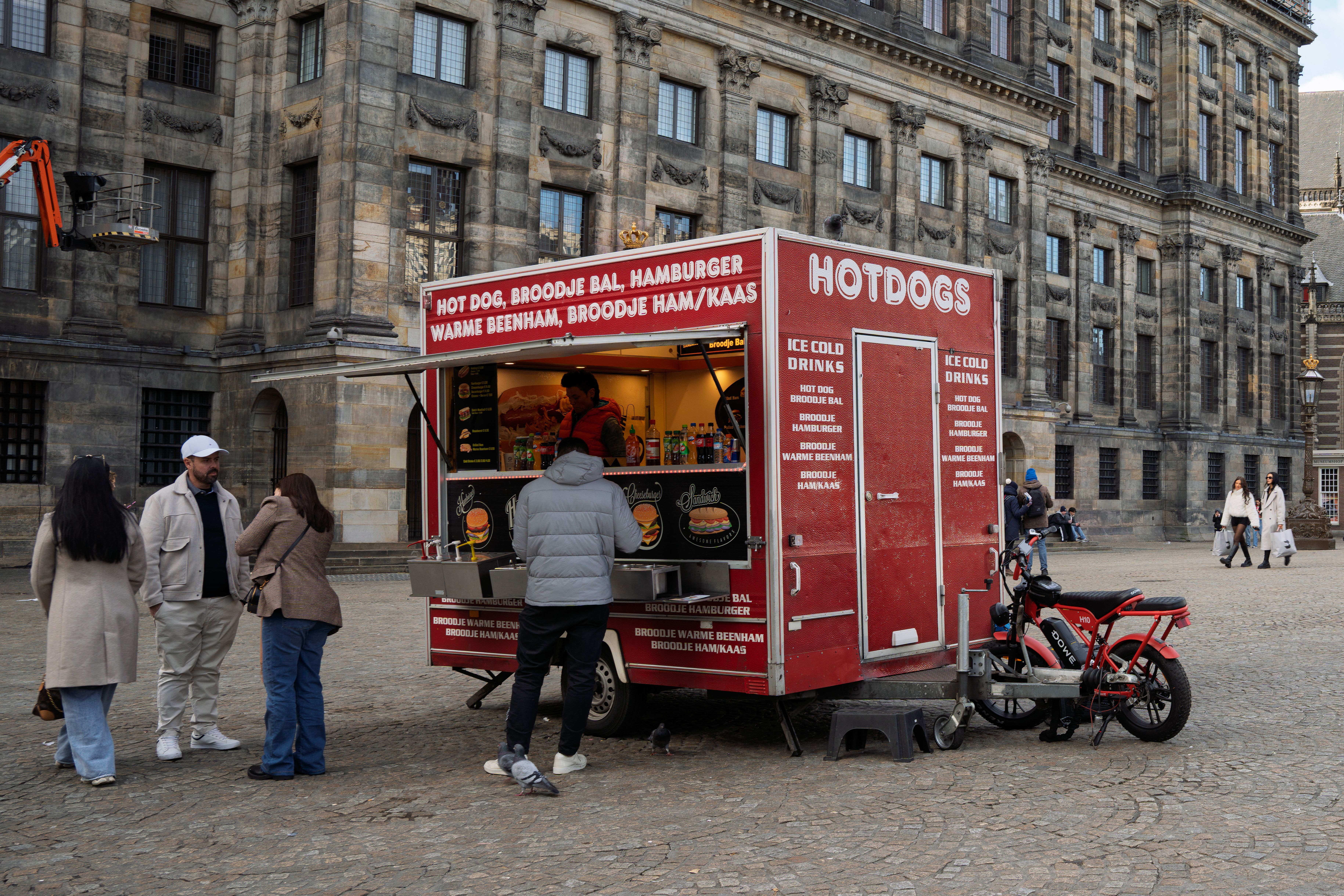 Street Food Vendor in Historic European Square · Free Stock Photo