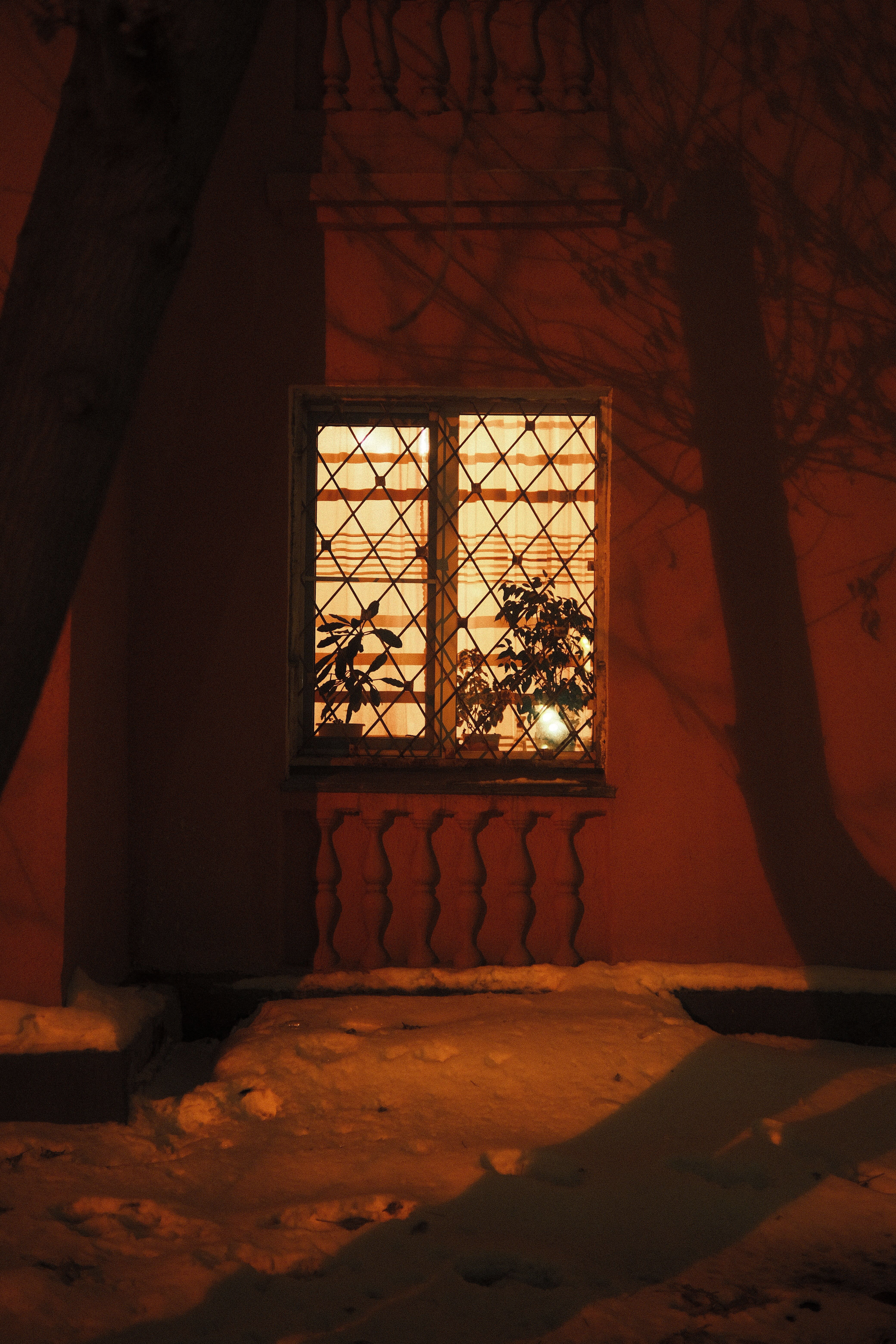 Cozy Window with Warm Glow on Snowy Night · Free Stock Photo