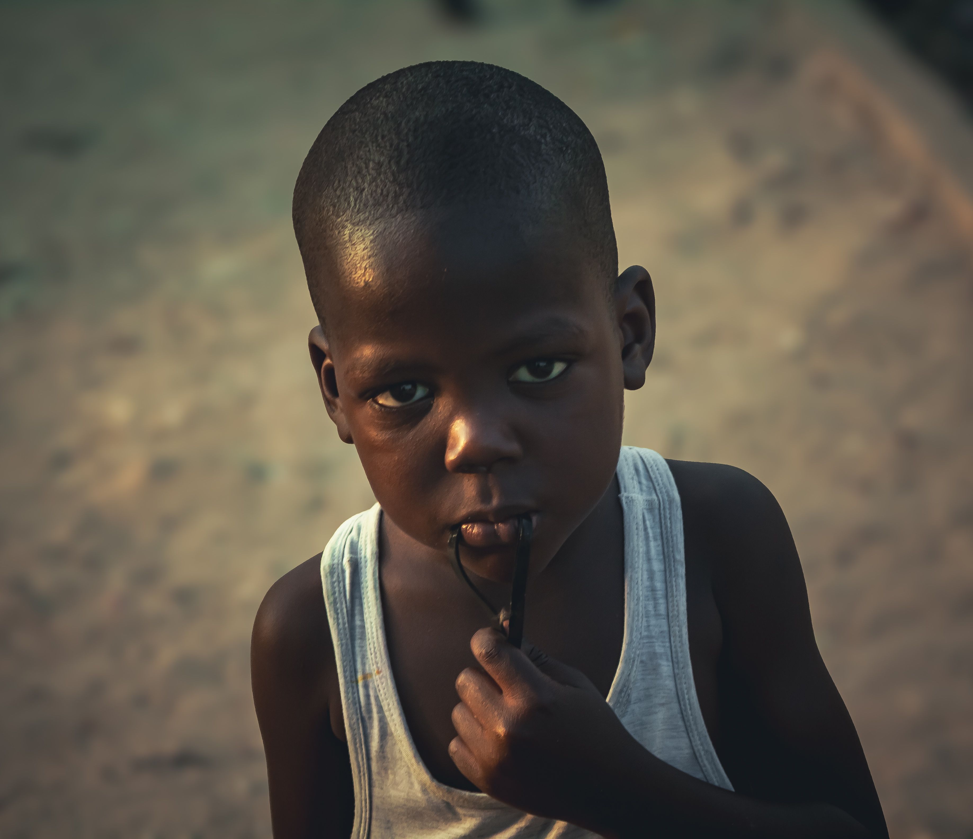 Thoughtful Child Outdoors at Dusk · Free Stock Photo