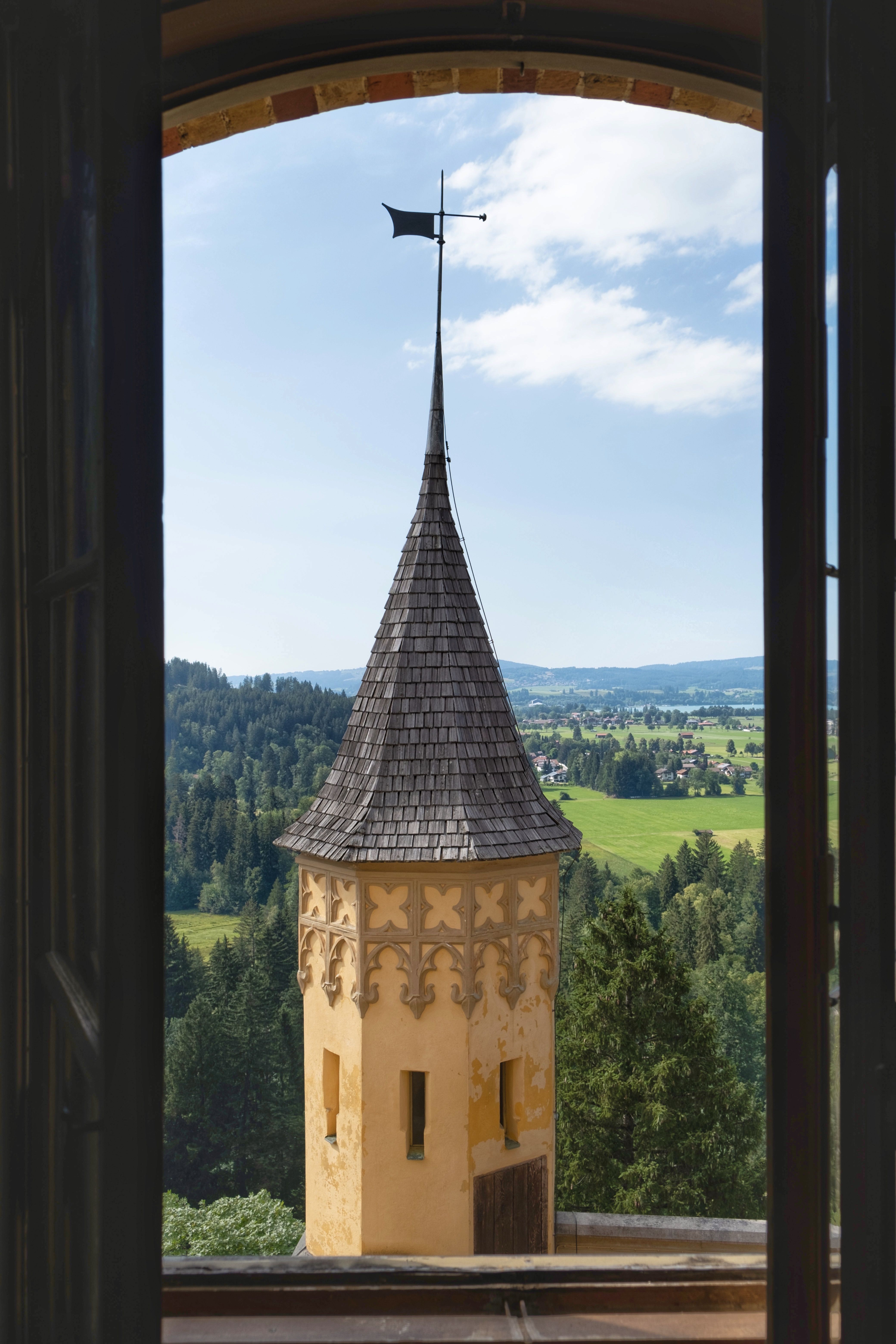 Scenic View of Castle Tower Through Window · Free Stock Photo