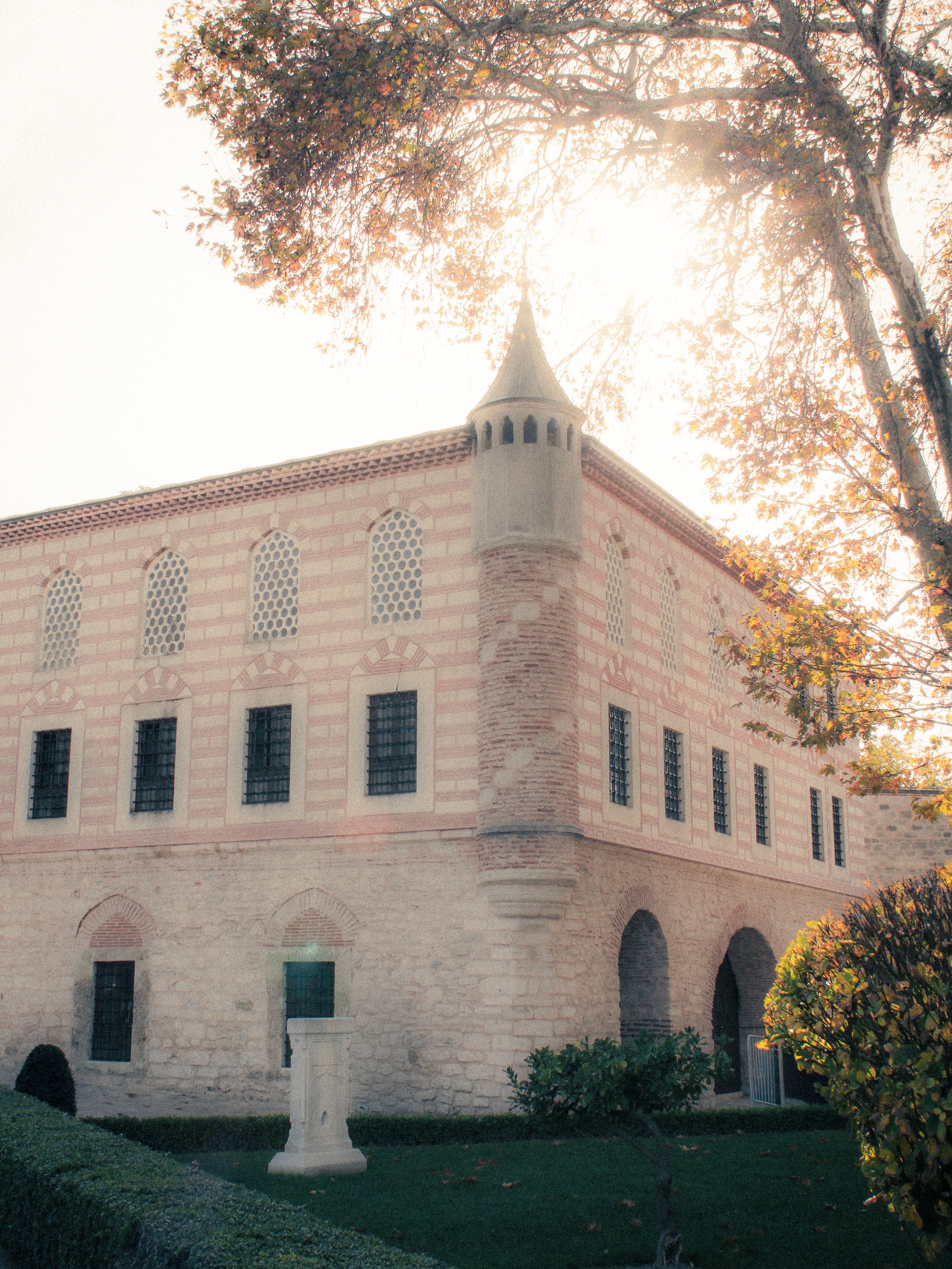 Sunlit Historic Building with Autumn Foliage · Free Stock Photo