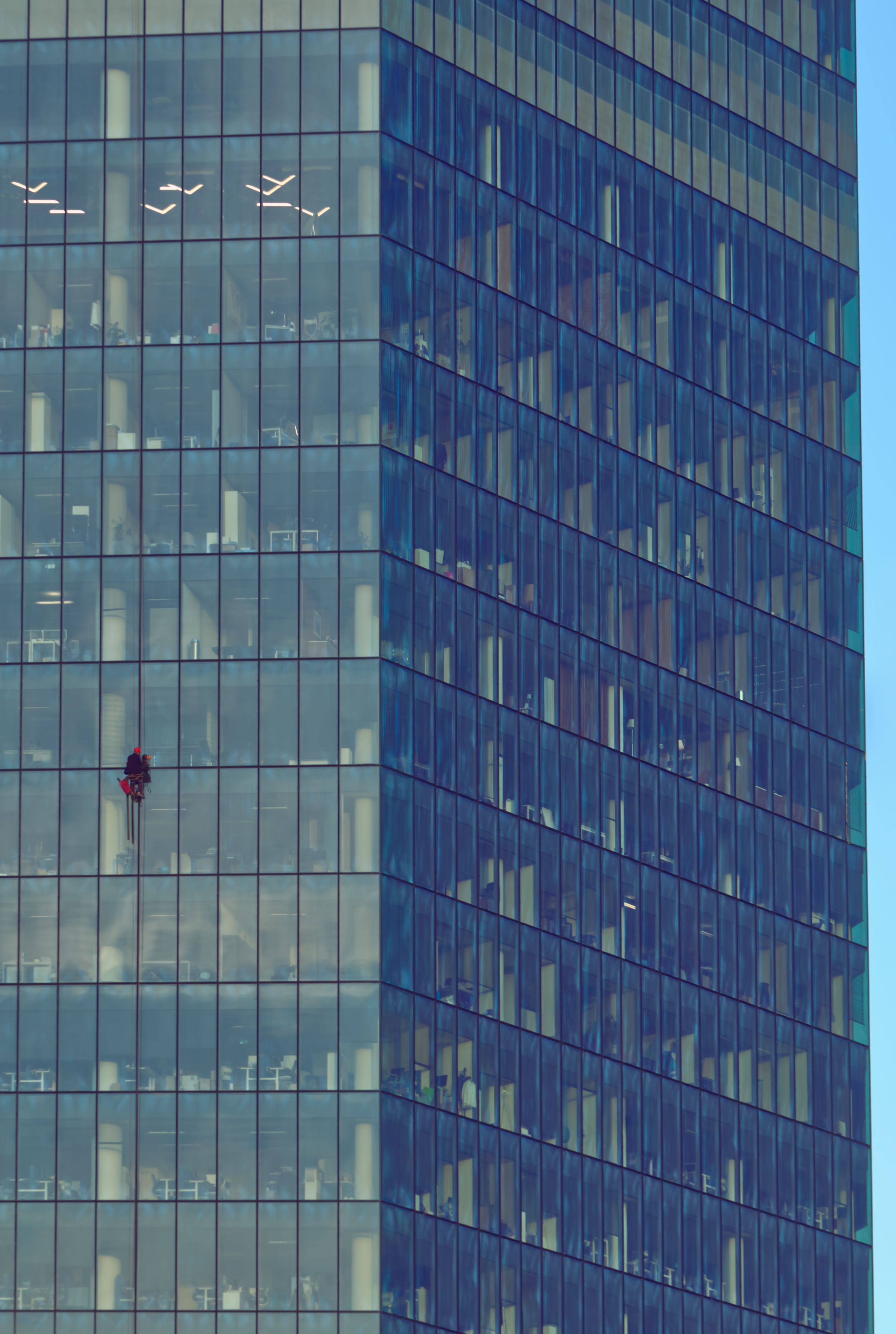 Window Cleaner Scaling Modern Glass Skyscraper · Free Stock Photo