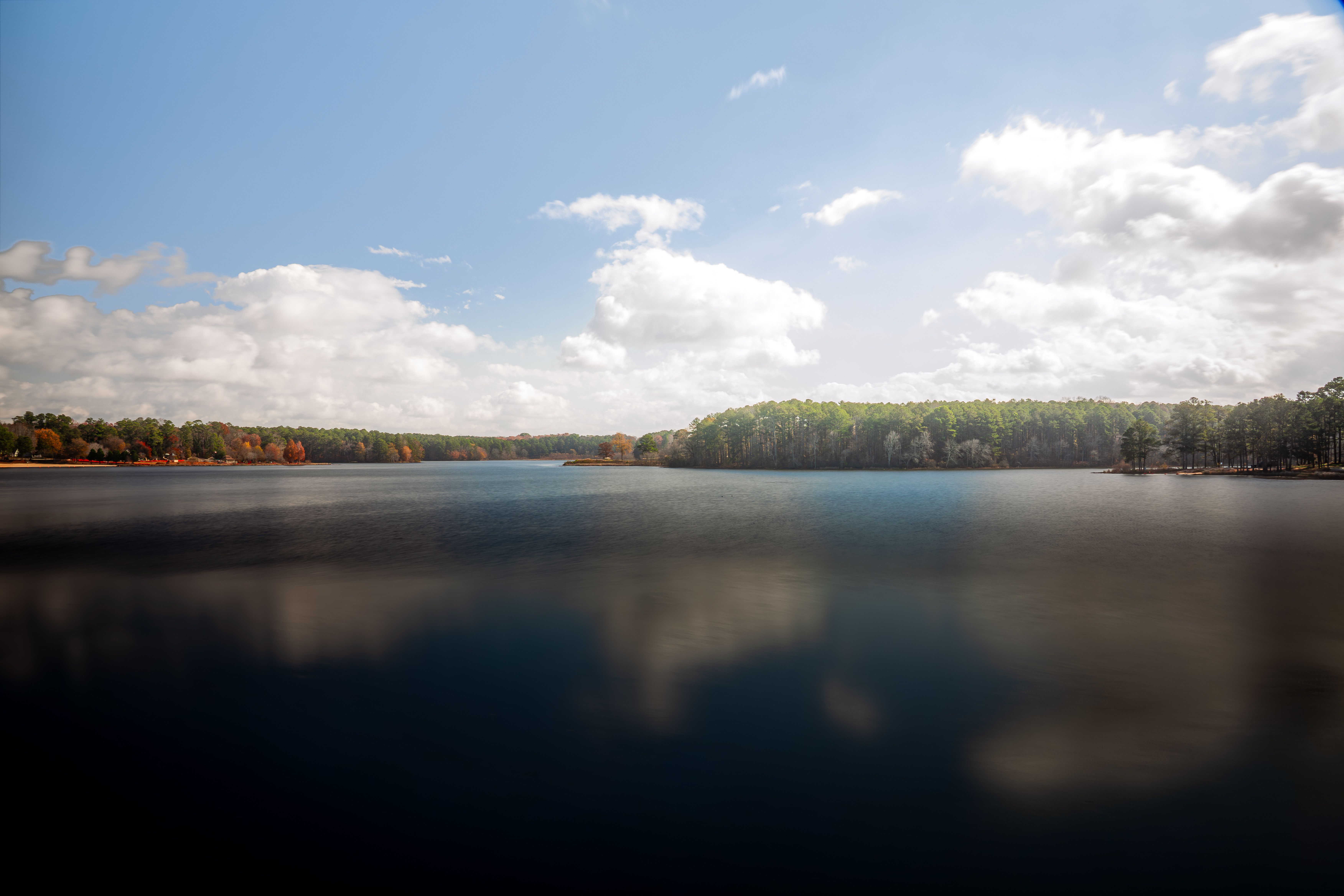 Peaceful Lake with Autumn Trees Under Blue Sky · Free Stock Photo