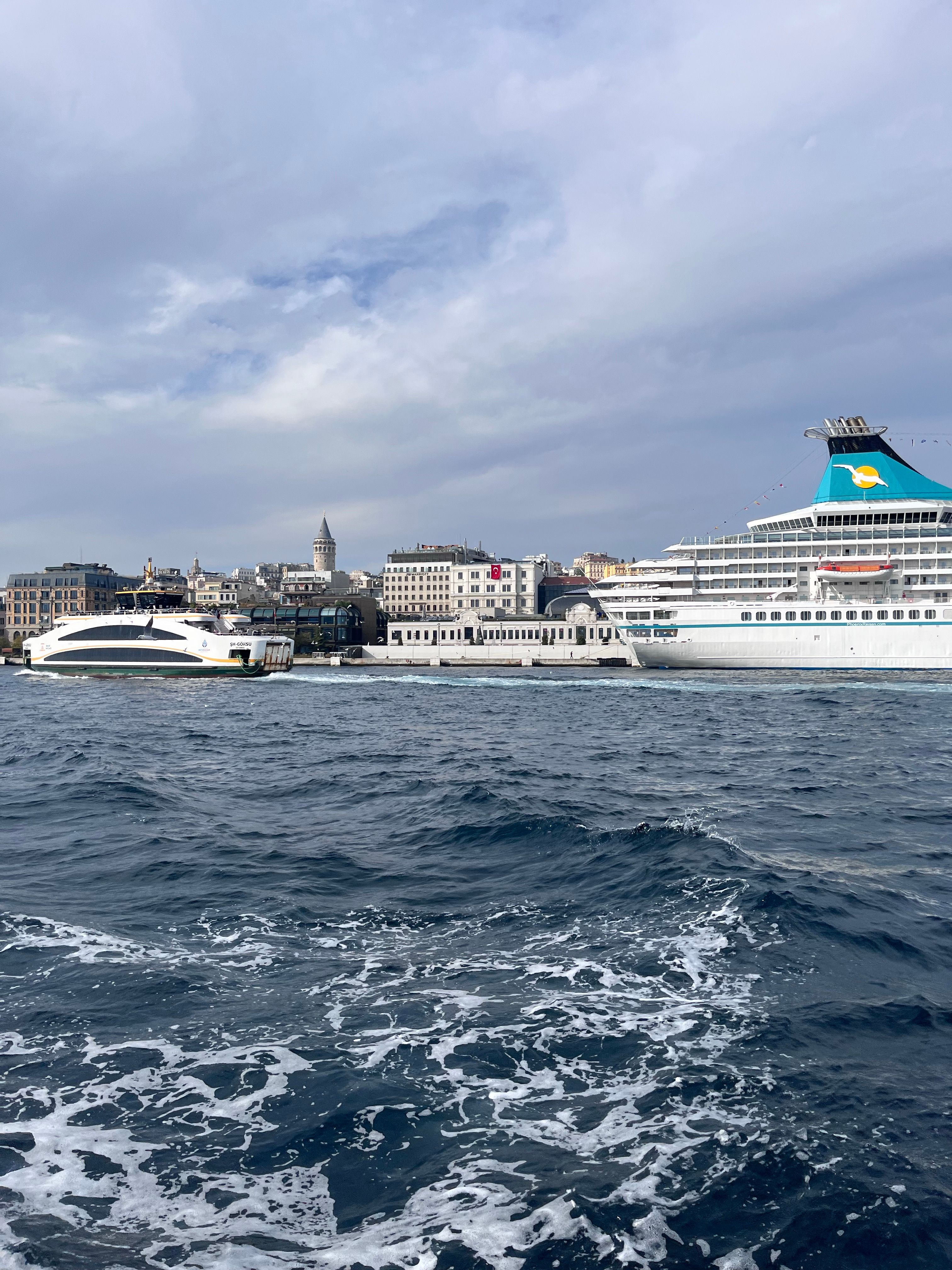 Cruise Ships Docked Near Iconic Tower at Seaside City · Free Stock Photo