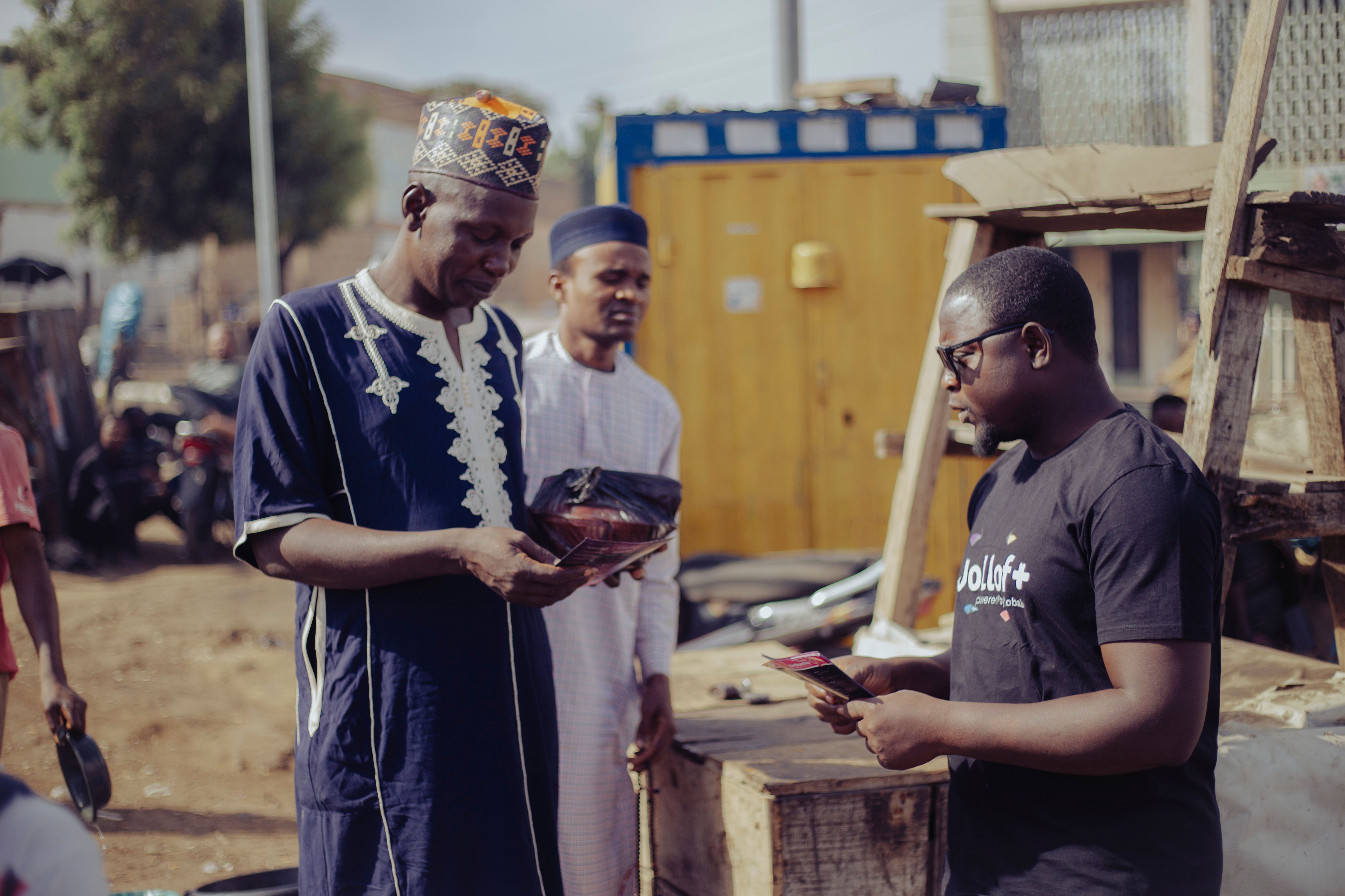 African Market Scene with Diverse Men Interacting · Free Stock Photo