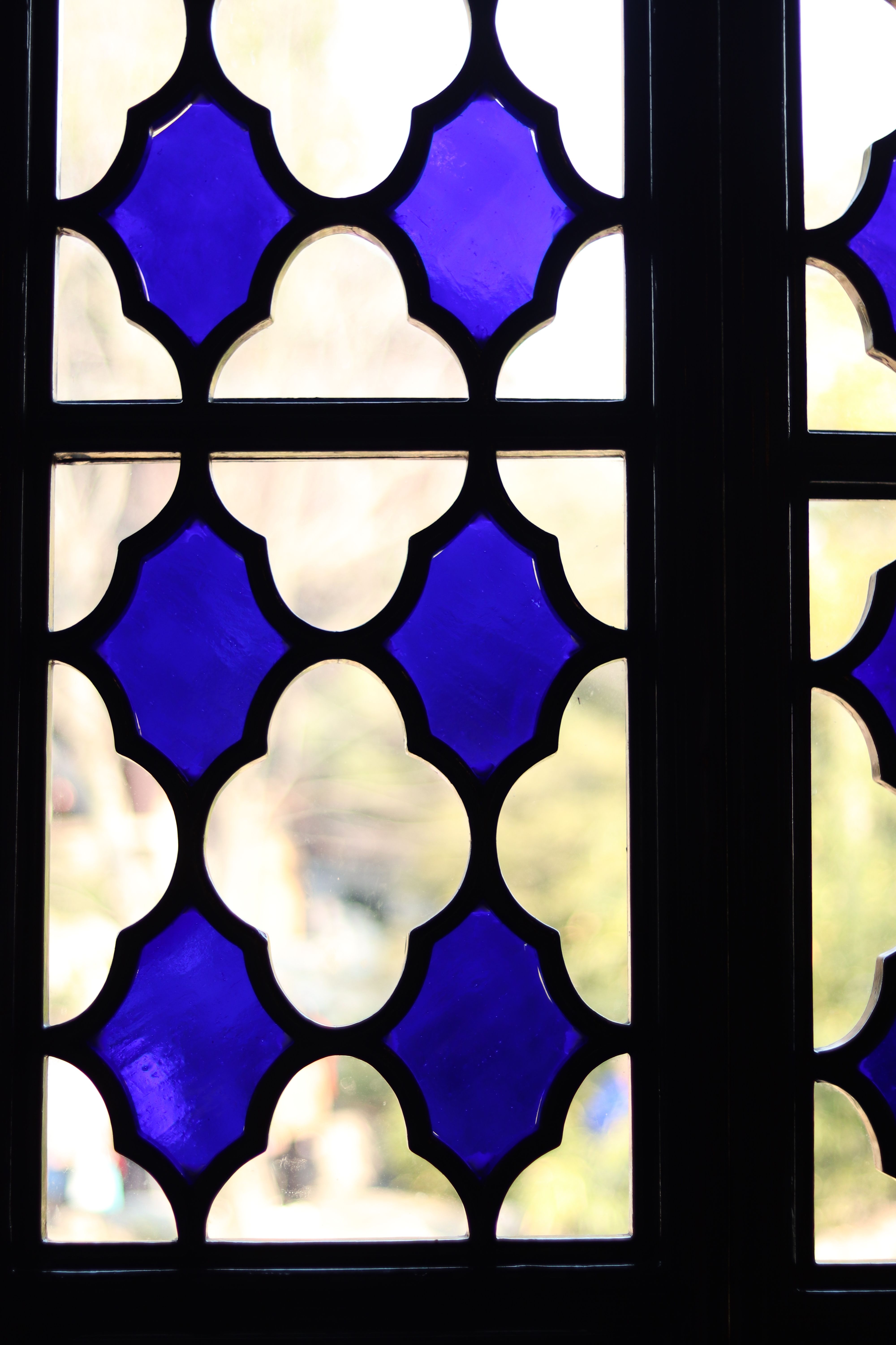Elegant Blue Stained Glass Window in Sunlight · Free Stock Photo