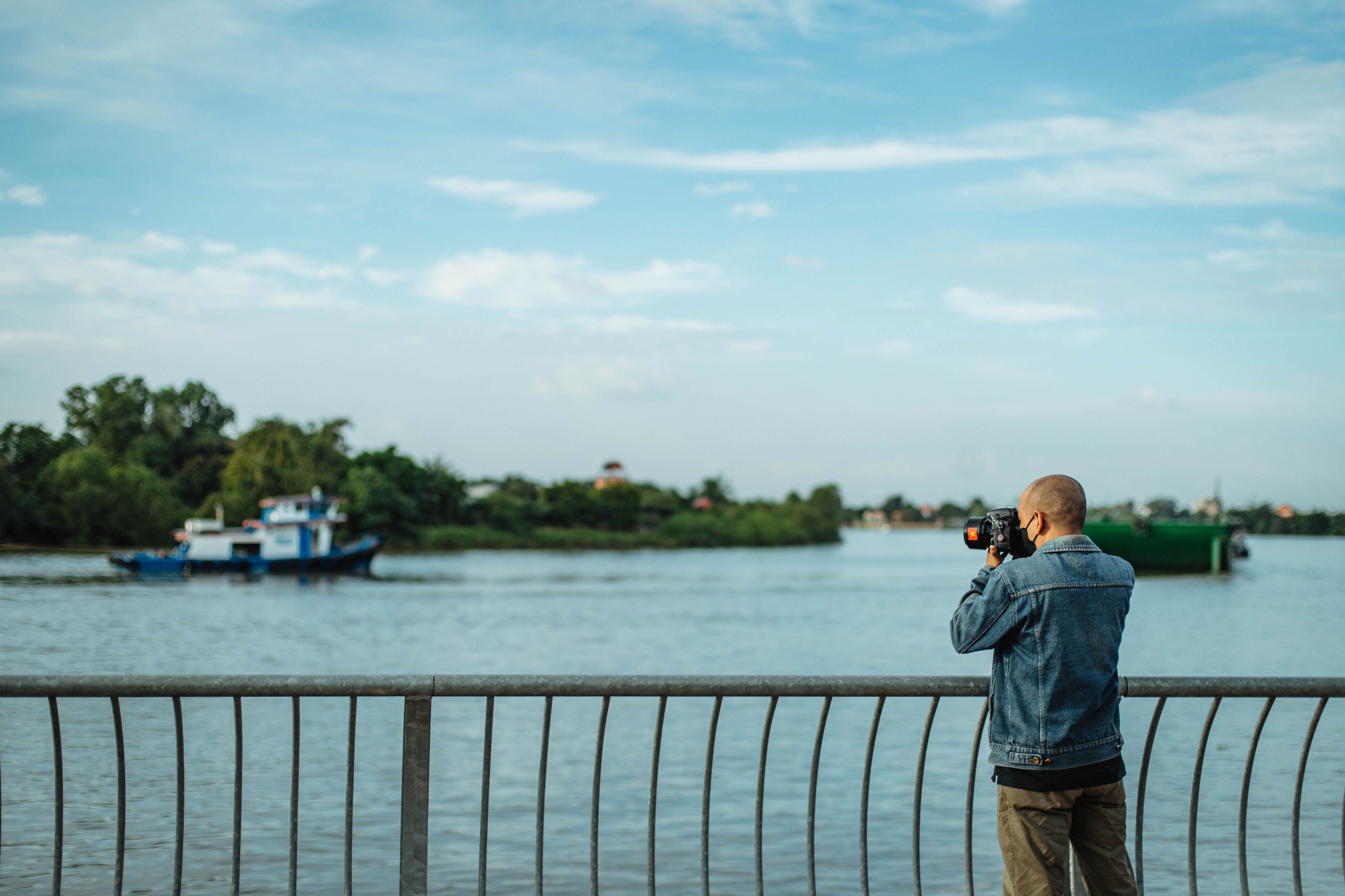 Photographer Capturing Riverside Scene · Free Stock Photo