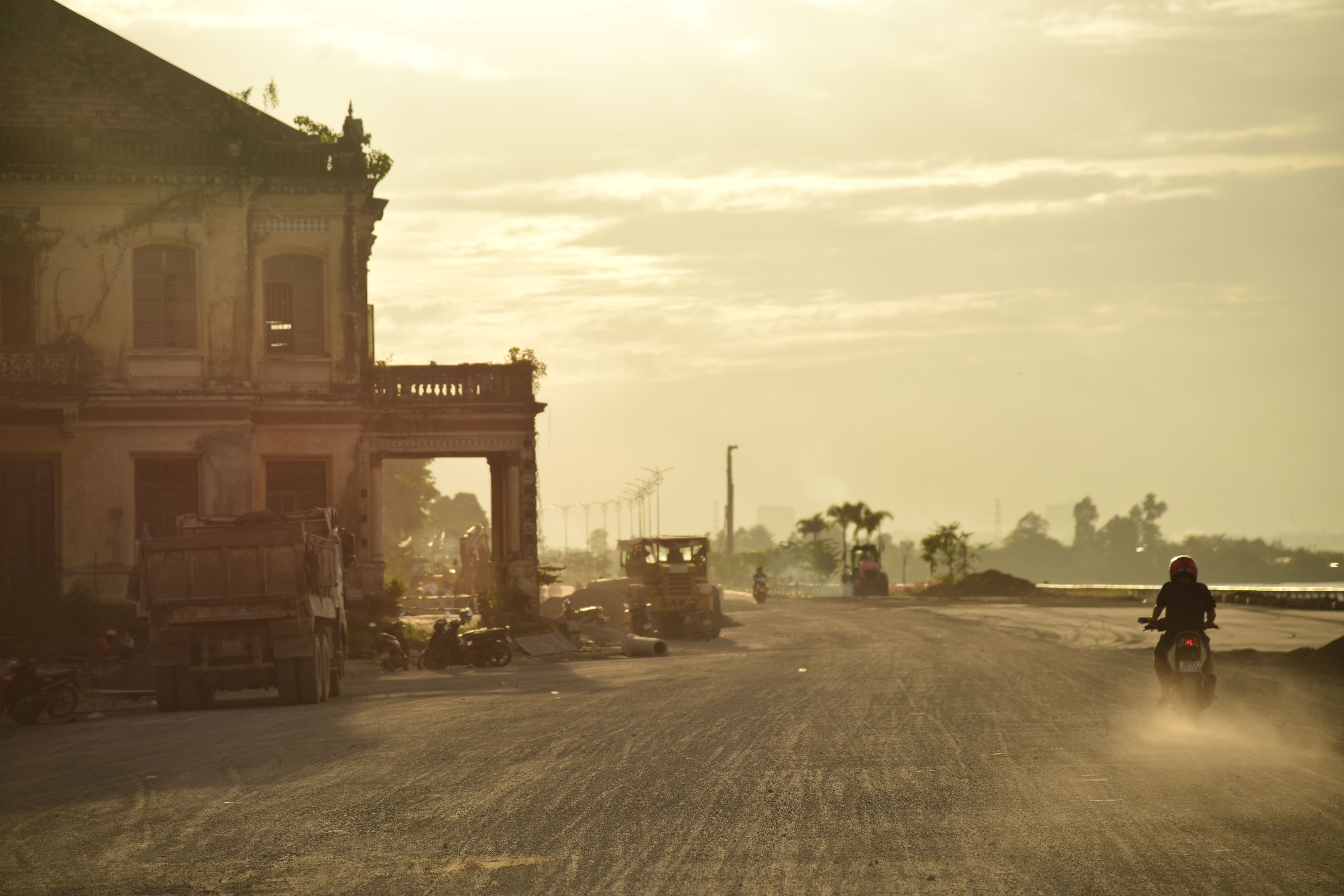 Dusty Road at Sunset with Motorbike and Building · Free Stock Photo