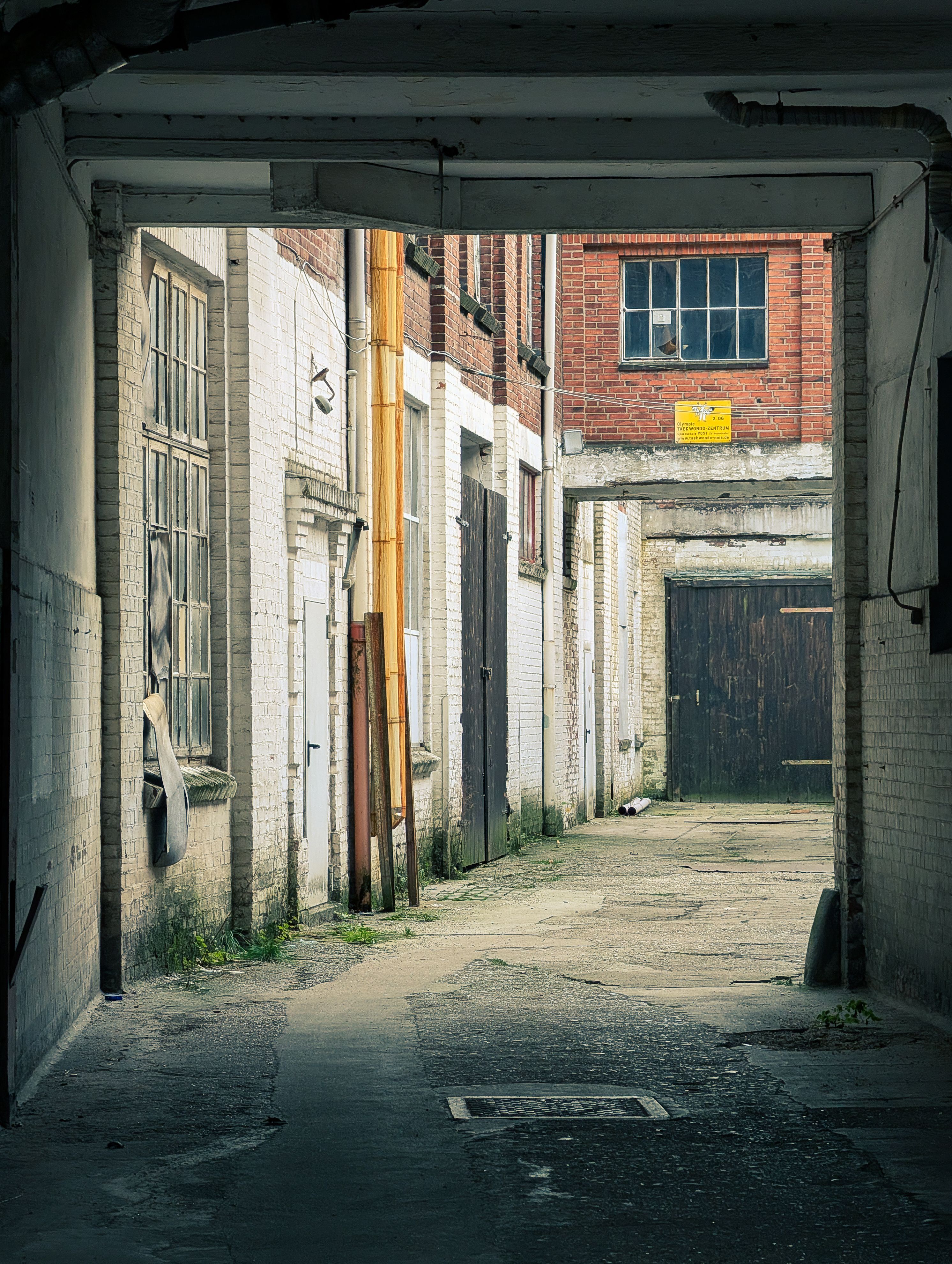 Abandoned Industrial Alley with Brick Walls · Free Stock Photo