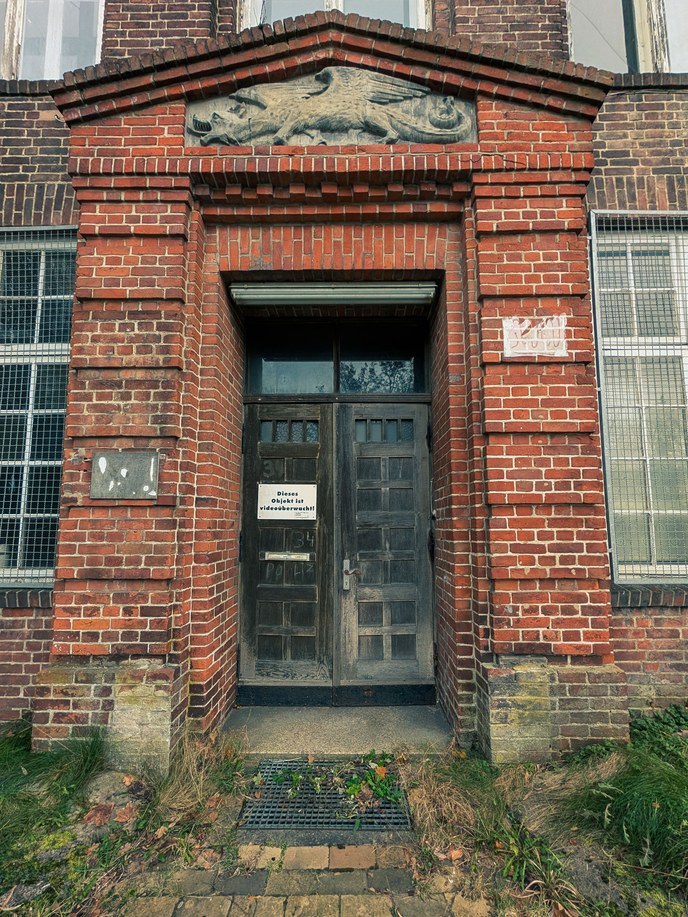 Historic Brick Entrance with Wooden Door · Free Stock Photo