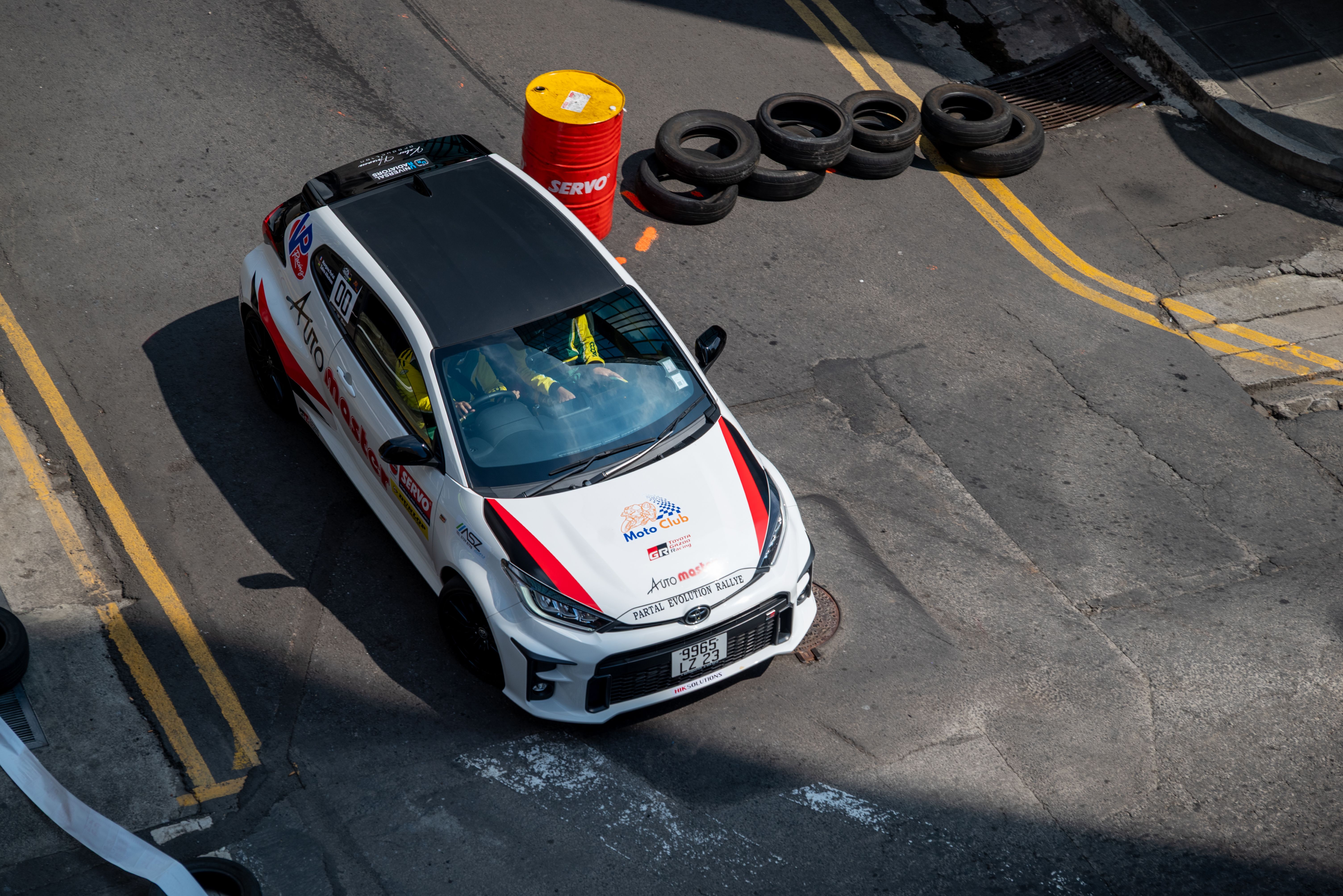Racing Car on Asphalt Track with Barrels · Free Stock Photo