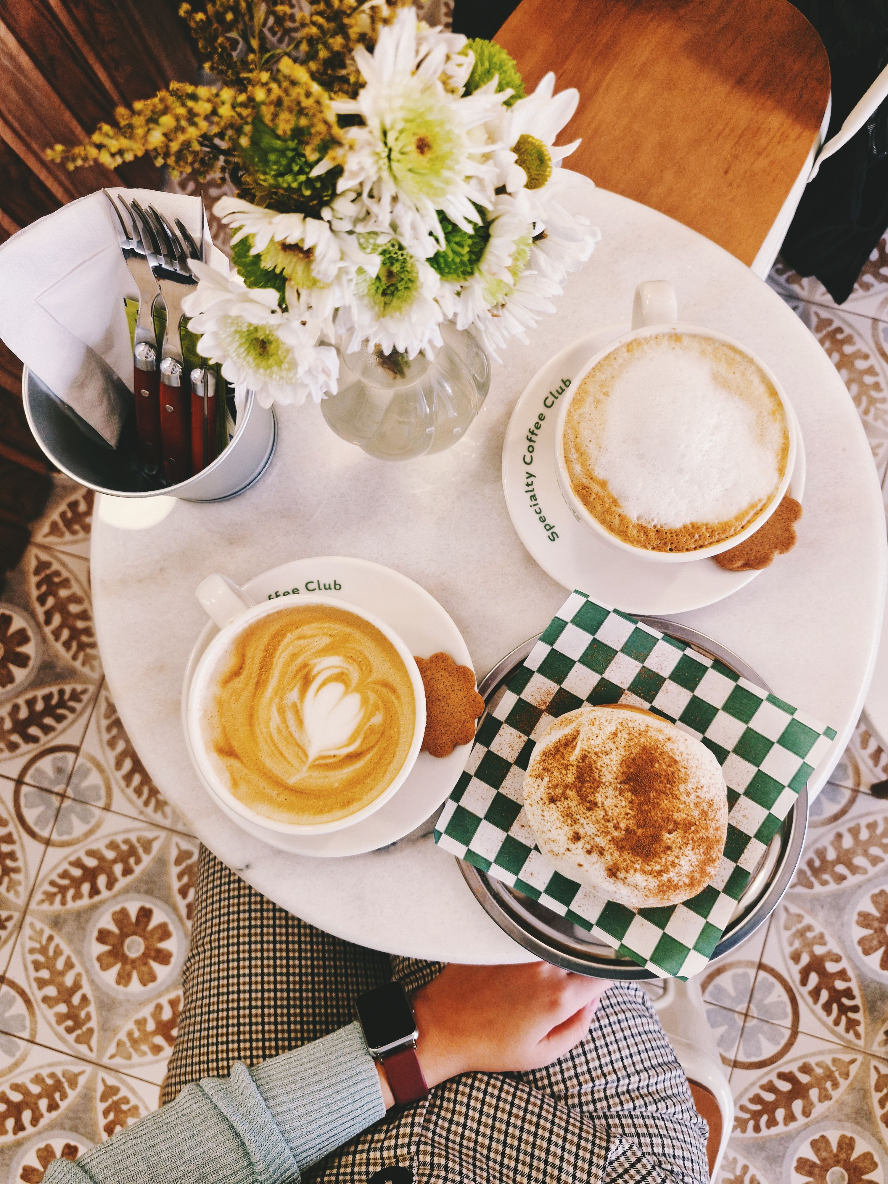Charming Cafe Table with Coffee and Pastries · Free Stock Photo