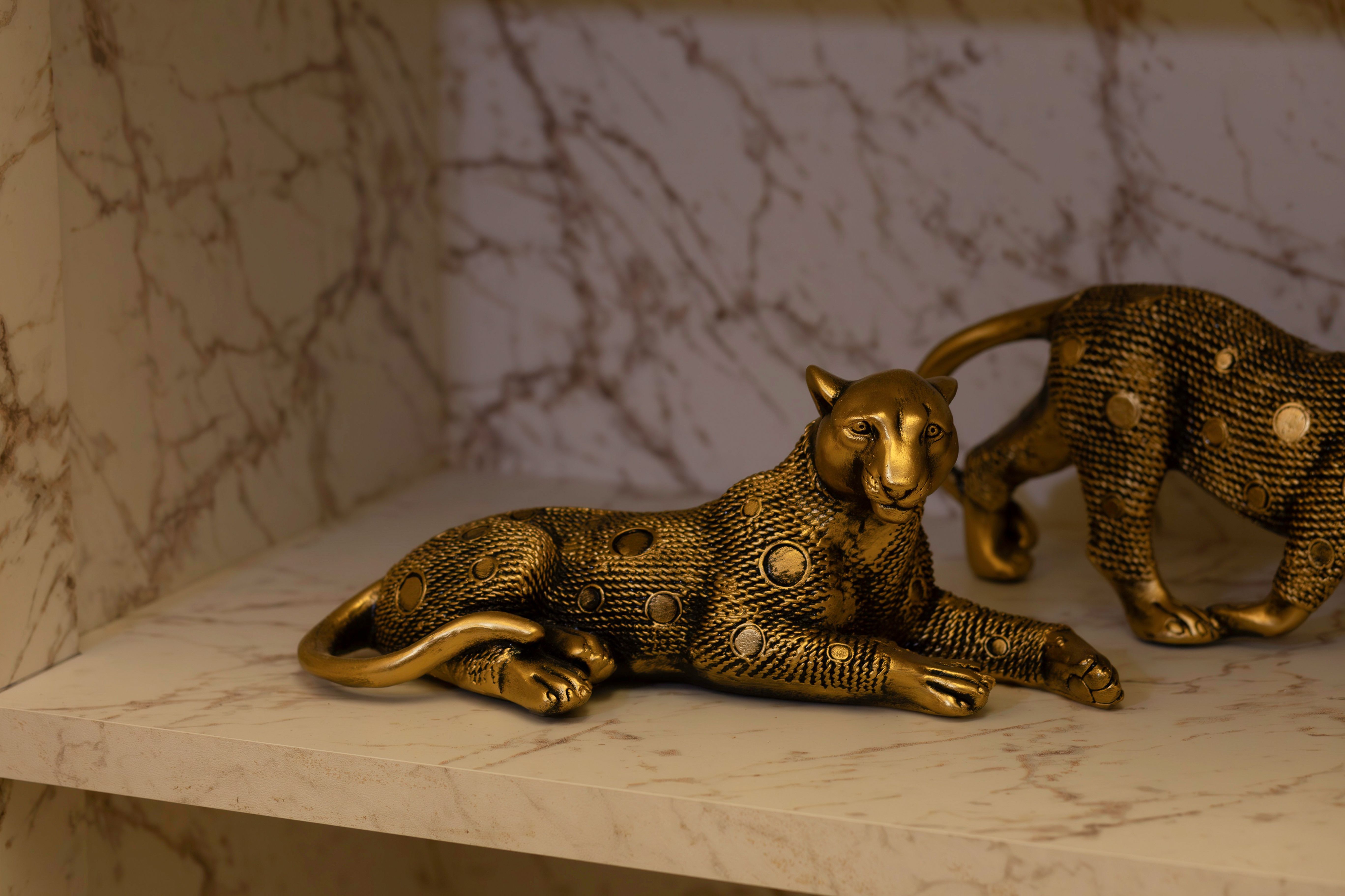 Elegant Golden Leopard Figurines on Marble Shelf · Free Stock Photo