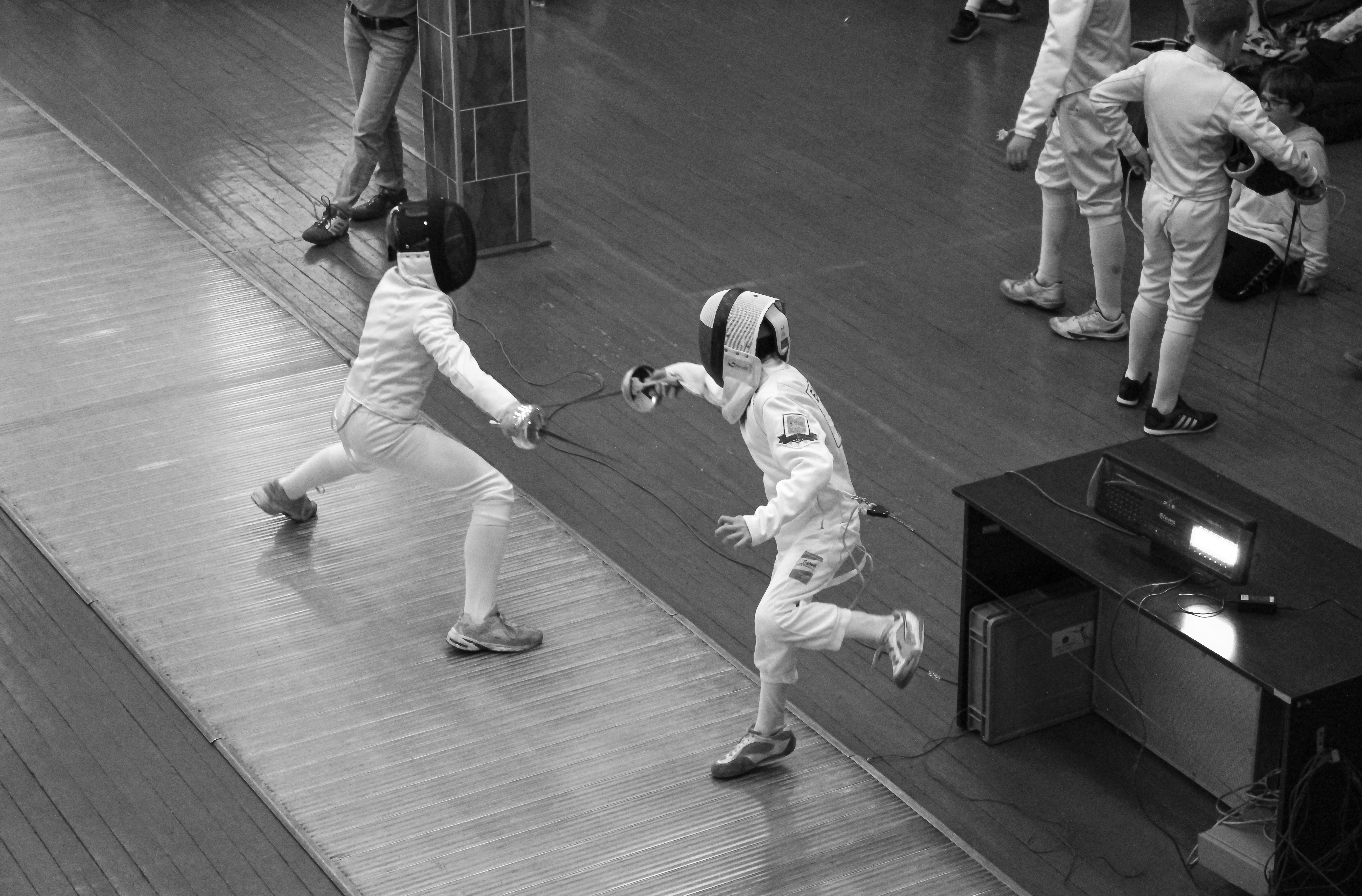 Intense Indoor Fencing Match in Action · Free Stock Photo
