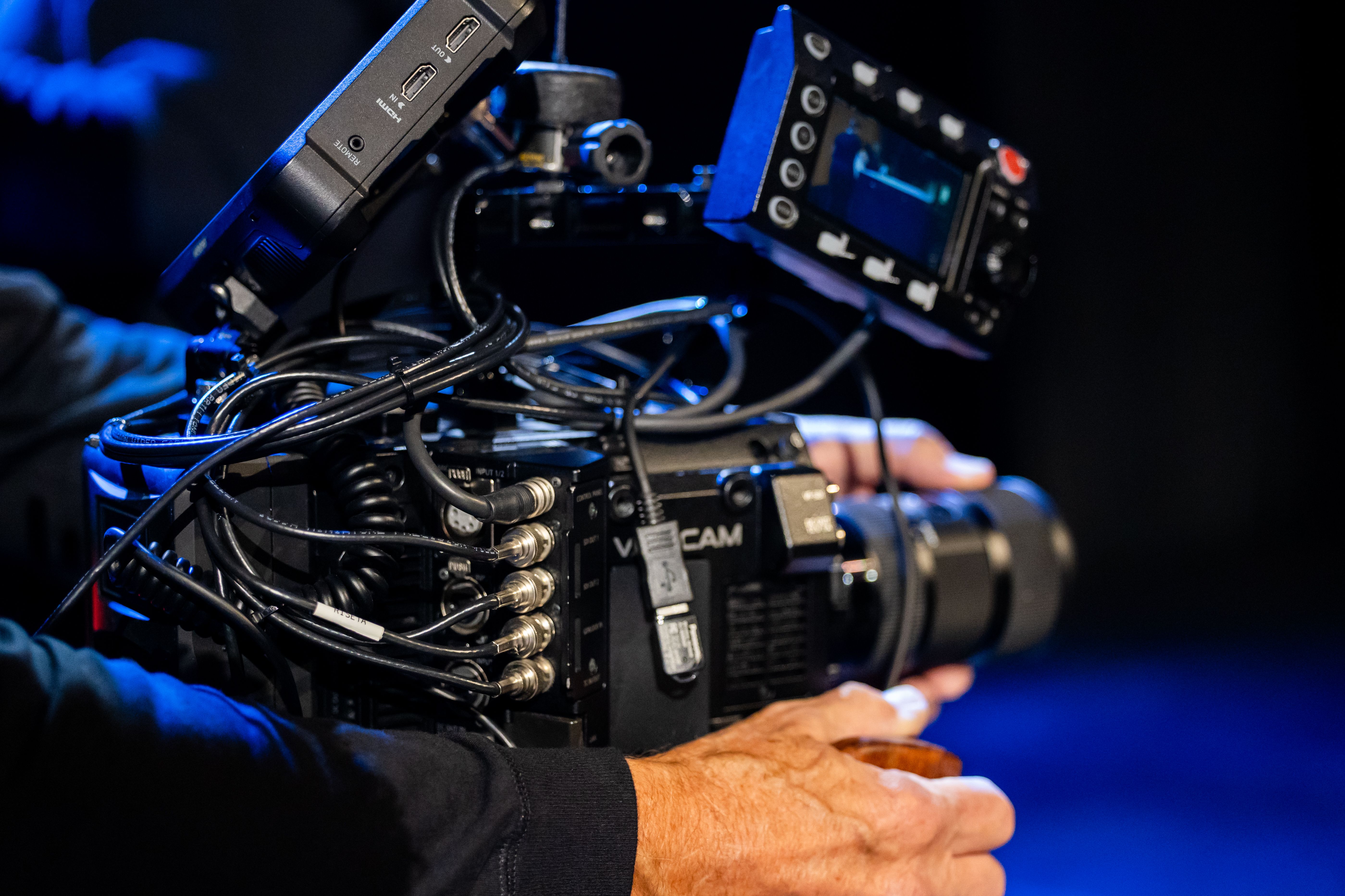 Professional Videographer Operating a Cinema Camera · Free Stock Photo