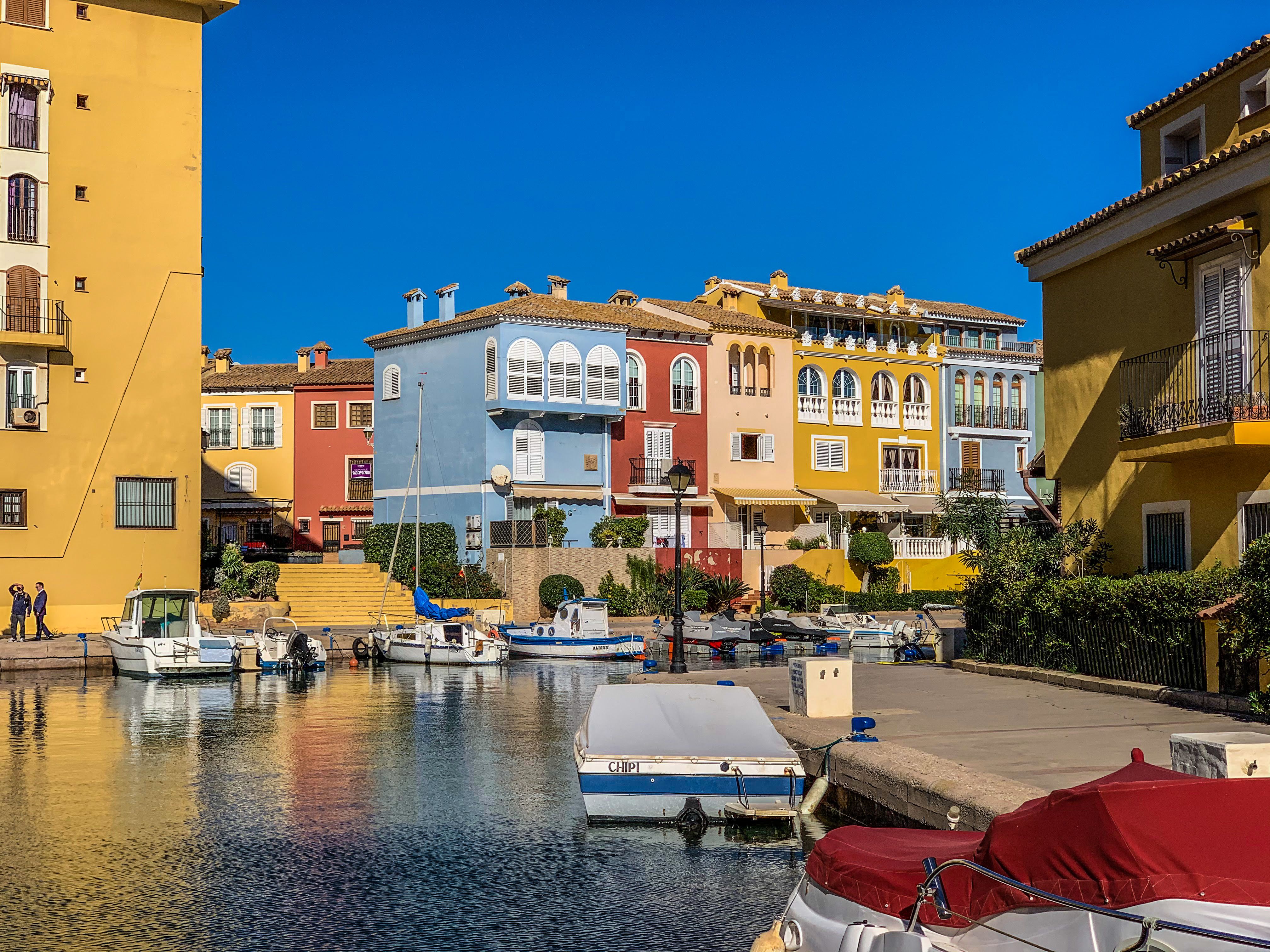 Colorful Waterfront Buildings in Serene Marina · Free Stock Photo