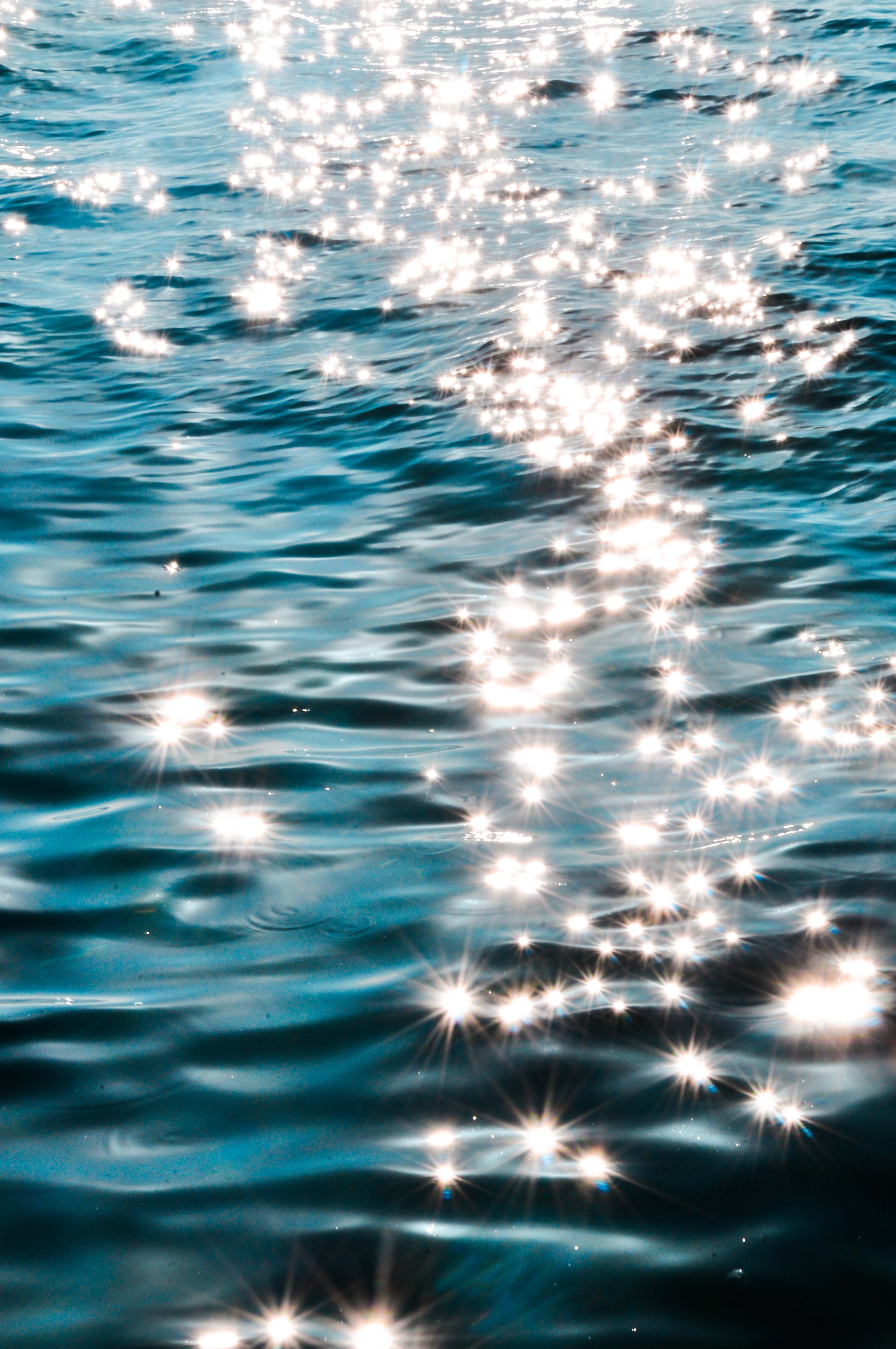 Sparkling Sunlight on Blue Water Surface · Free Stock Photo