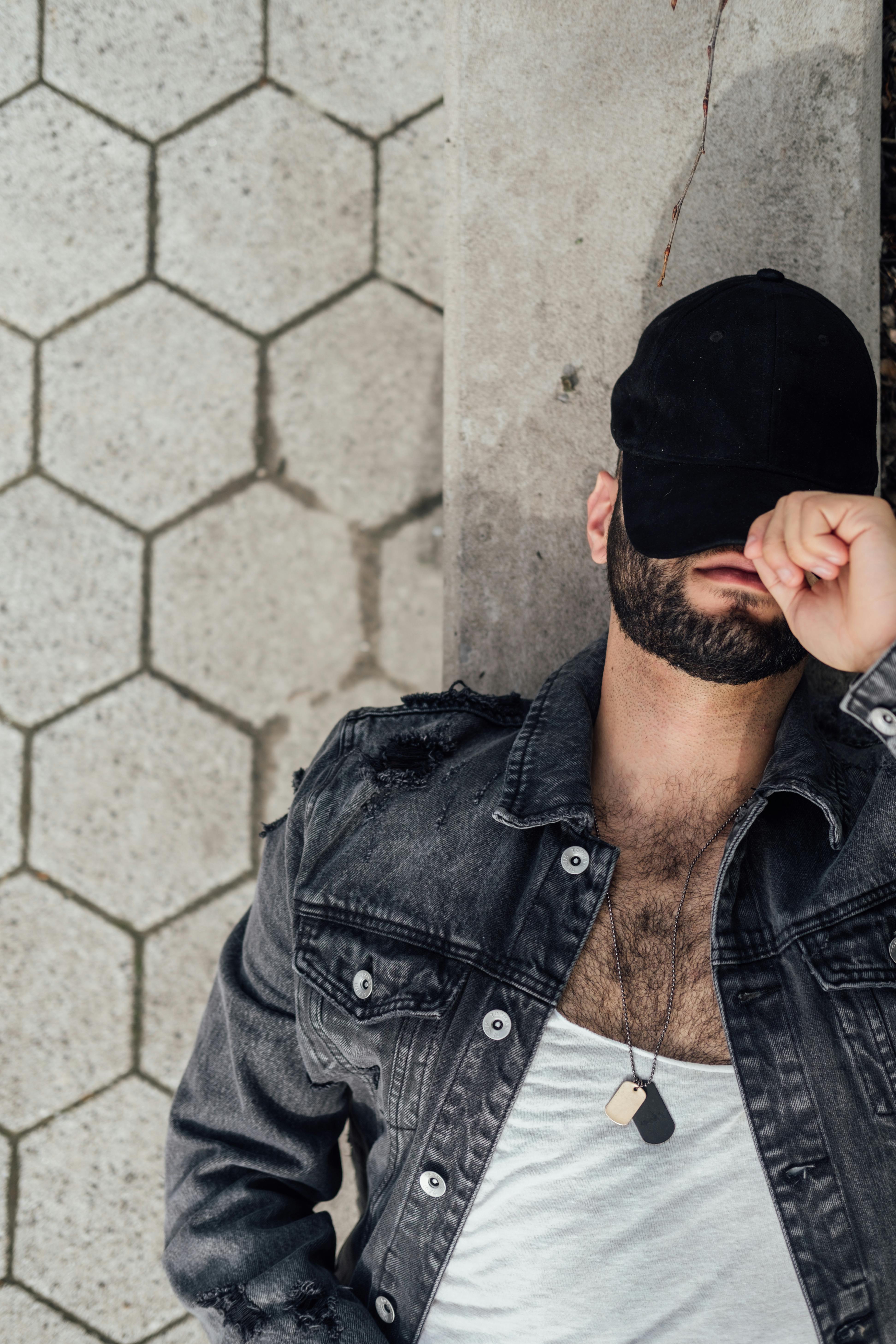 Faceless man resting on curb over pavement · Free Stock Photo