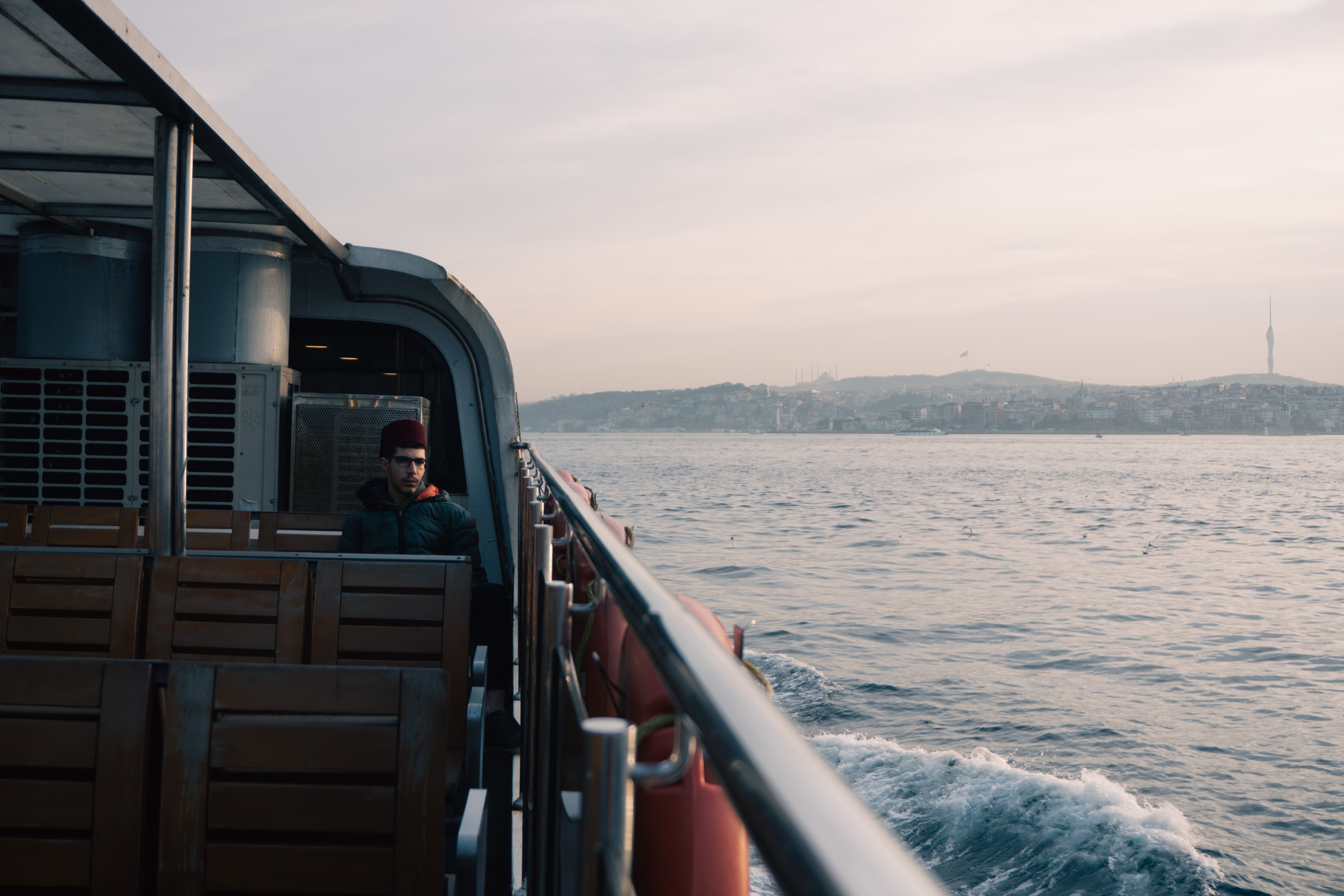 Man on Istanbul Ferry with View of Bosphorus · Free Stock Photo