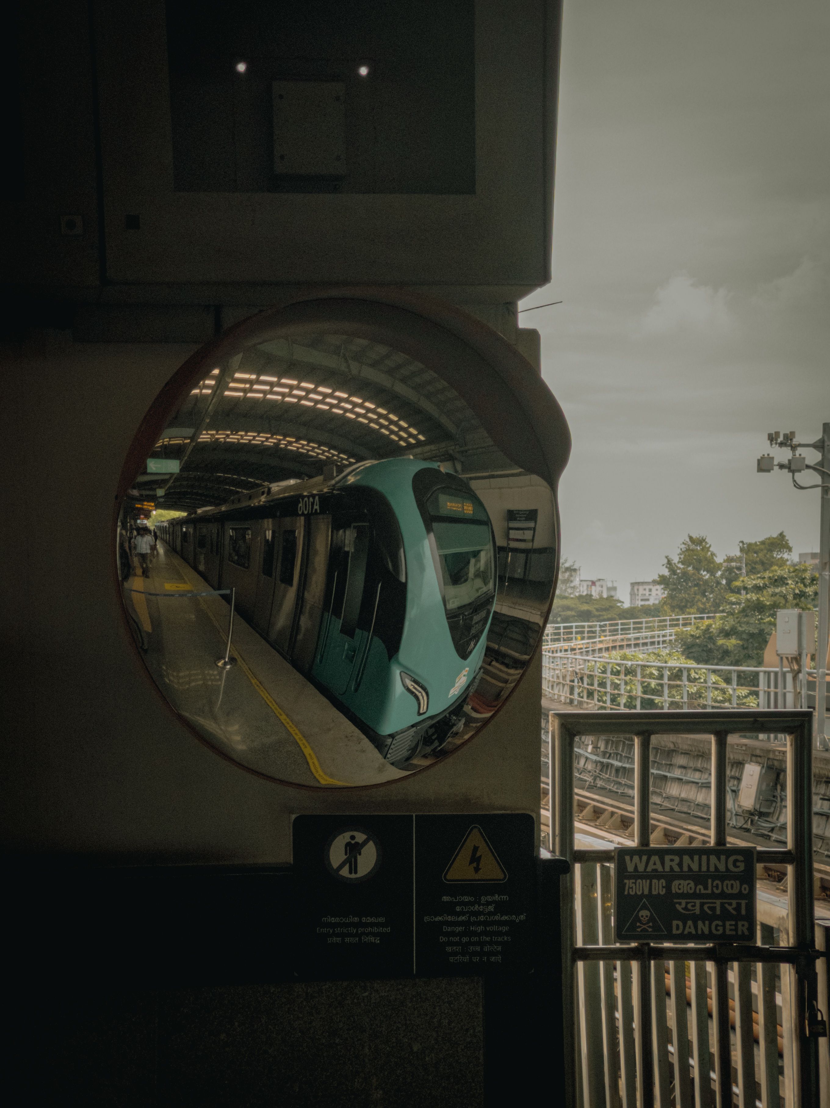 Reflection of Train in Safety Mirror at Station · Free Stock Photo
