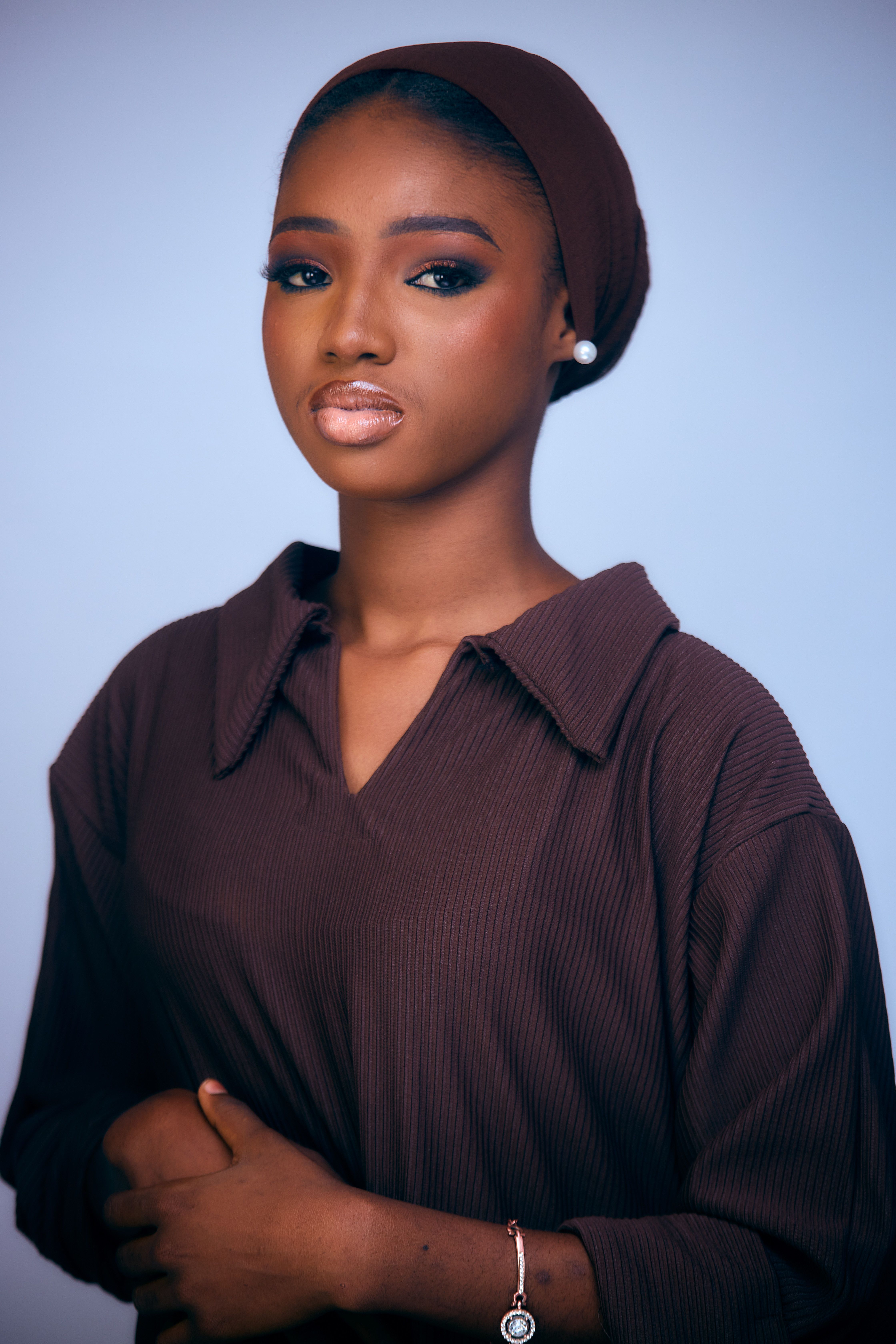 Portrait of a Confident Young Woman Wearing Brown · Free Stock Photo
