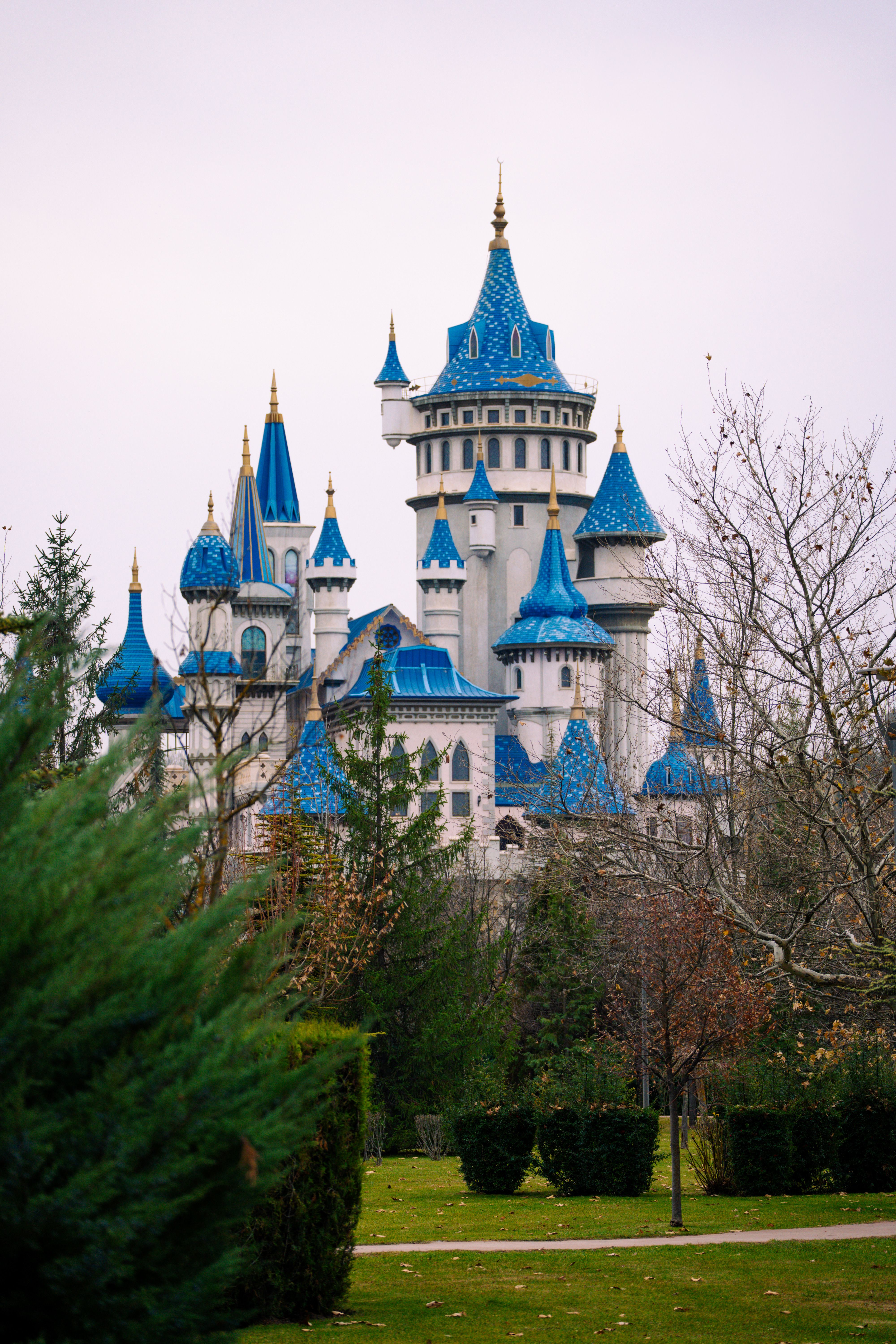 Majestic Blue-Topped Castle Amidst Lush Greenery · Free Stock Photo