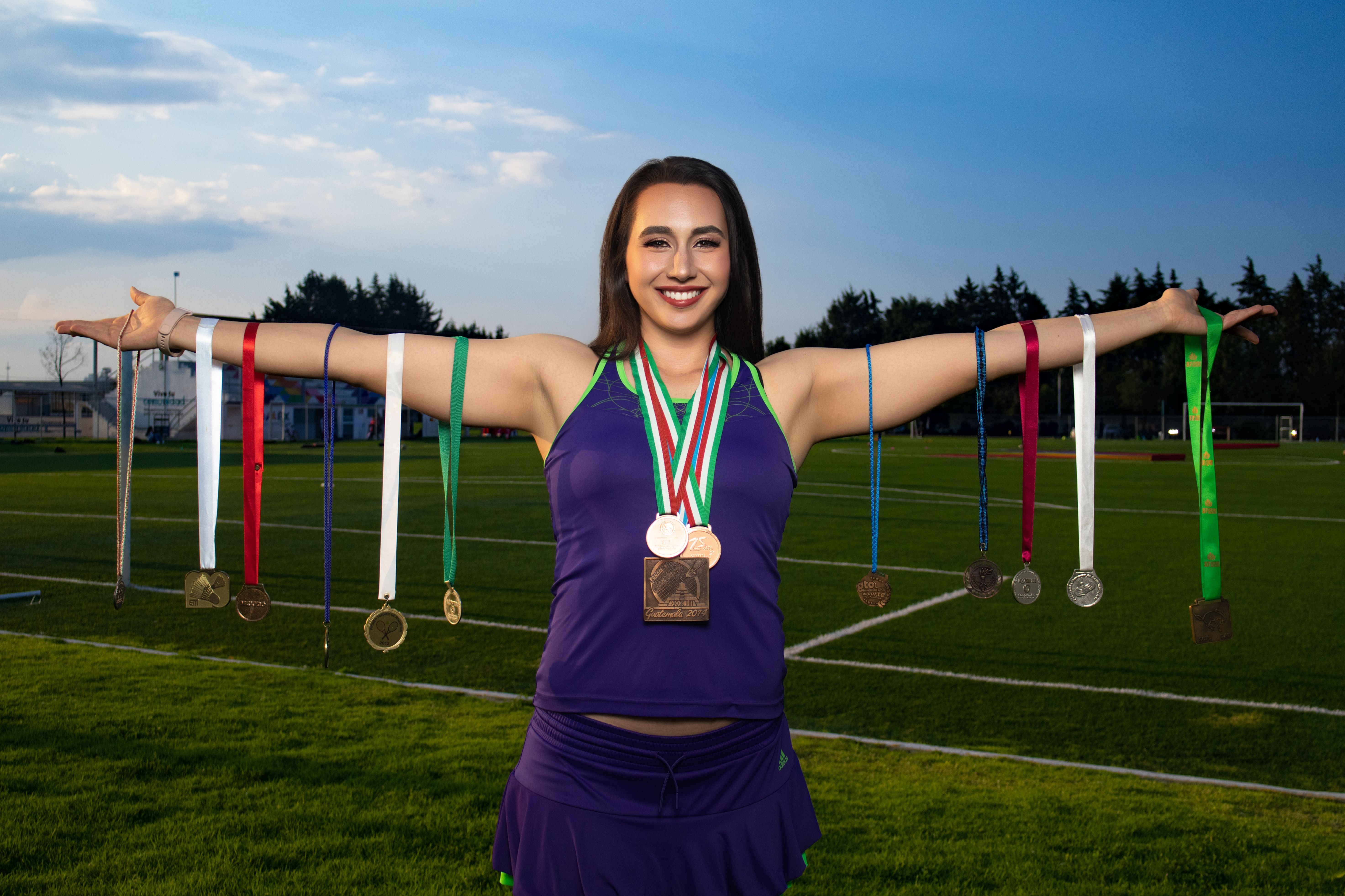 Female Athlete Celebrating with Multiple Medals · Free Stock Photo