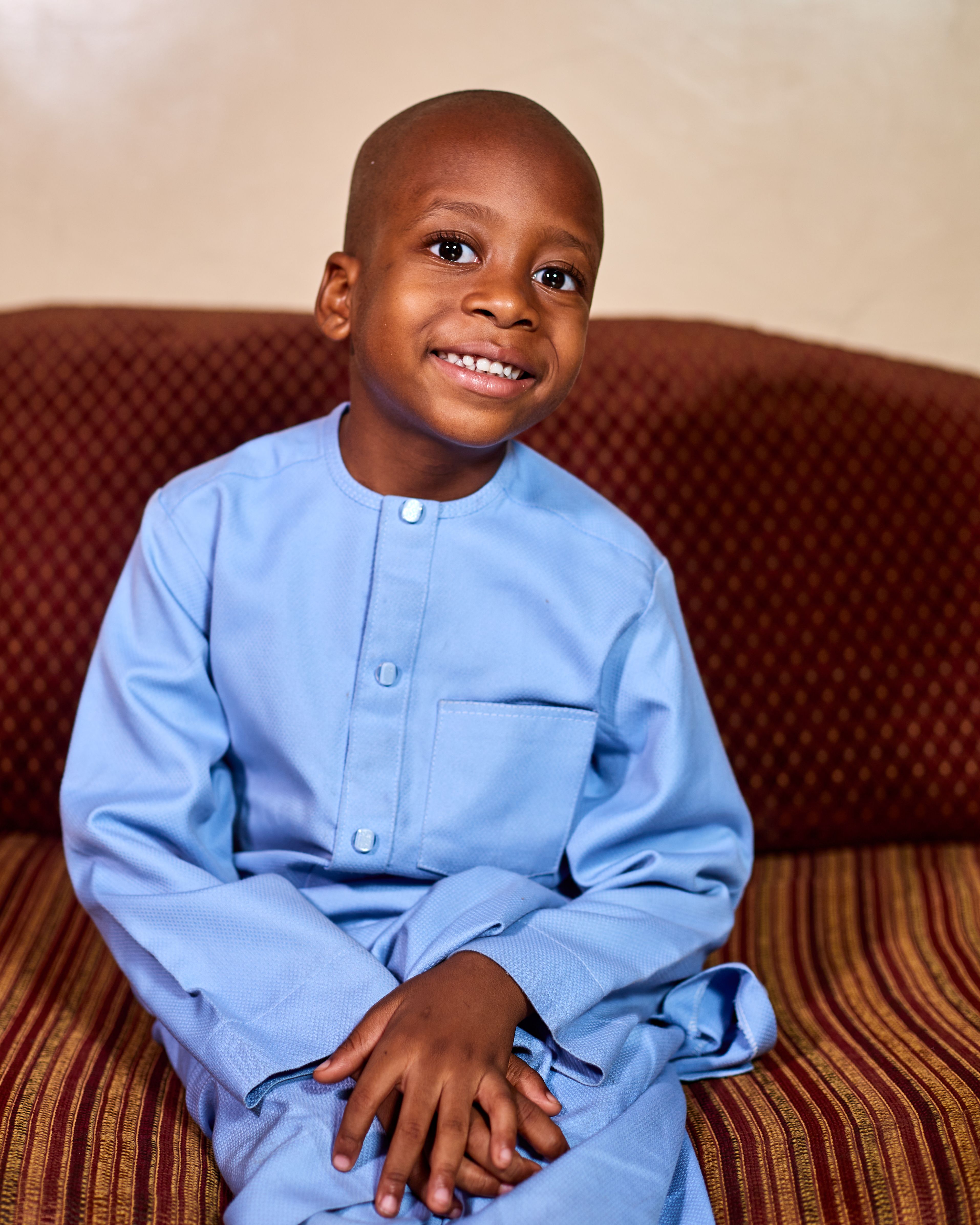 Portrait of a Smiling Nigerian Boy in Traditional Attire · Free Stock Photo