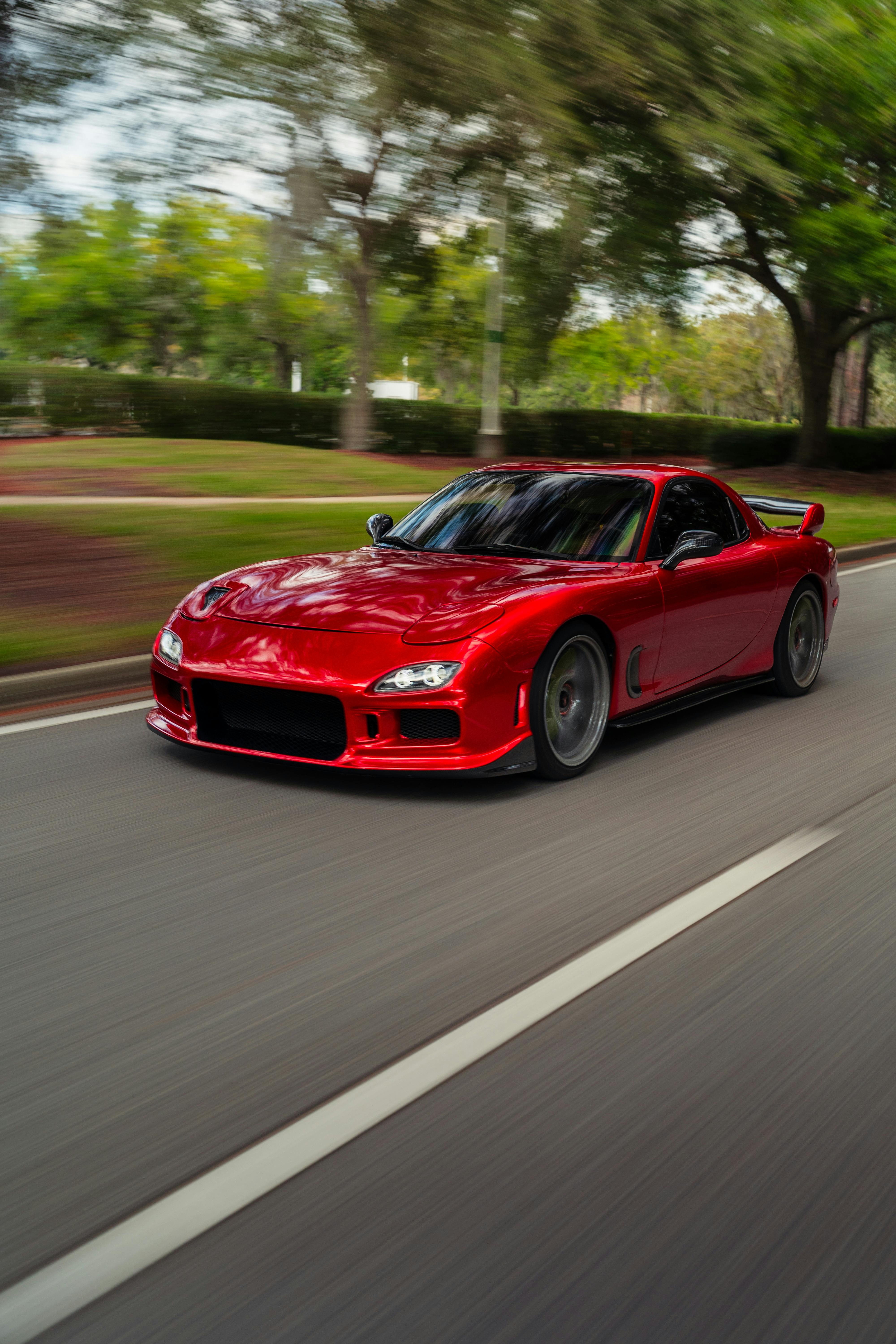 Sleek Red Sports Car on a Road · Free Stock Photo