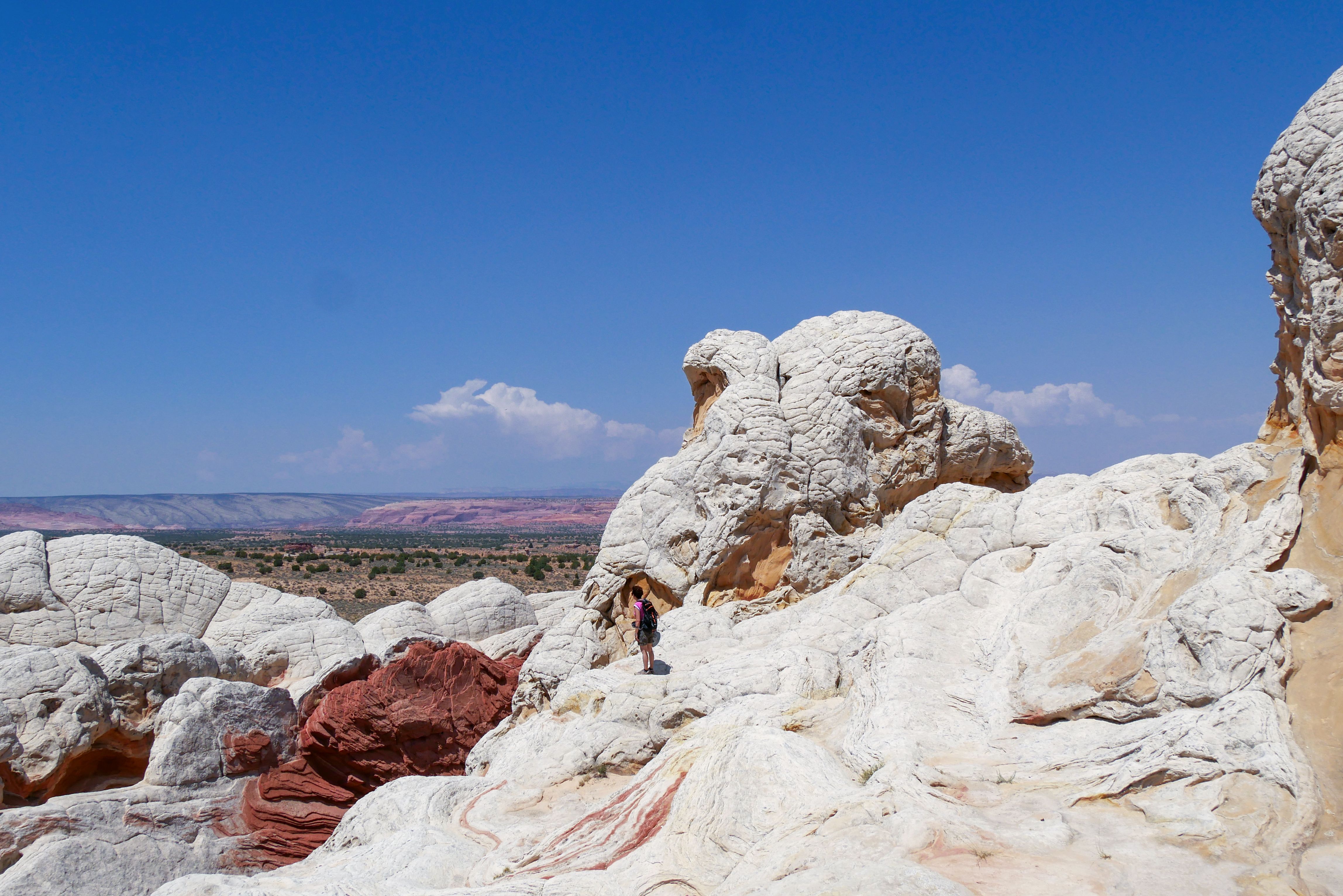 Hiker Exploring White Pocket Rock Formations · Free Stock Photo