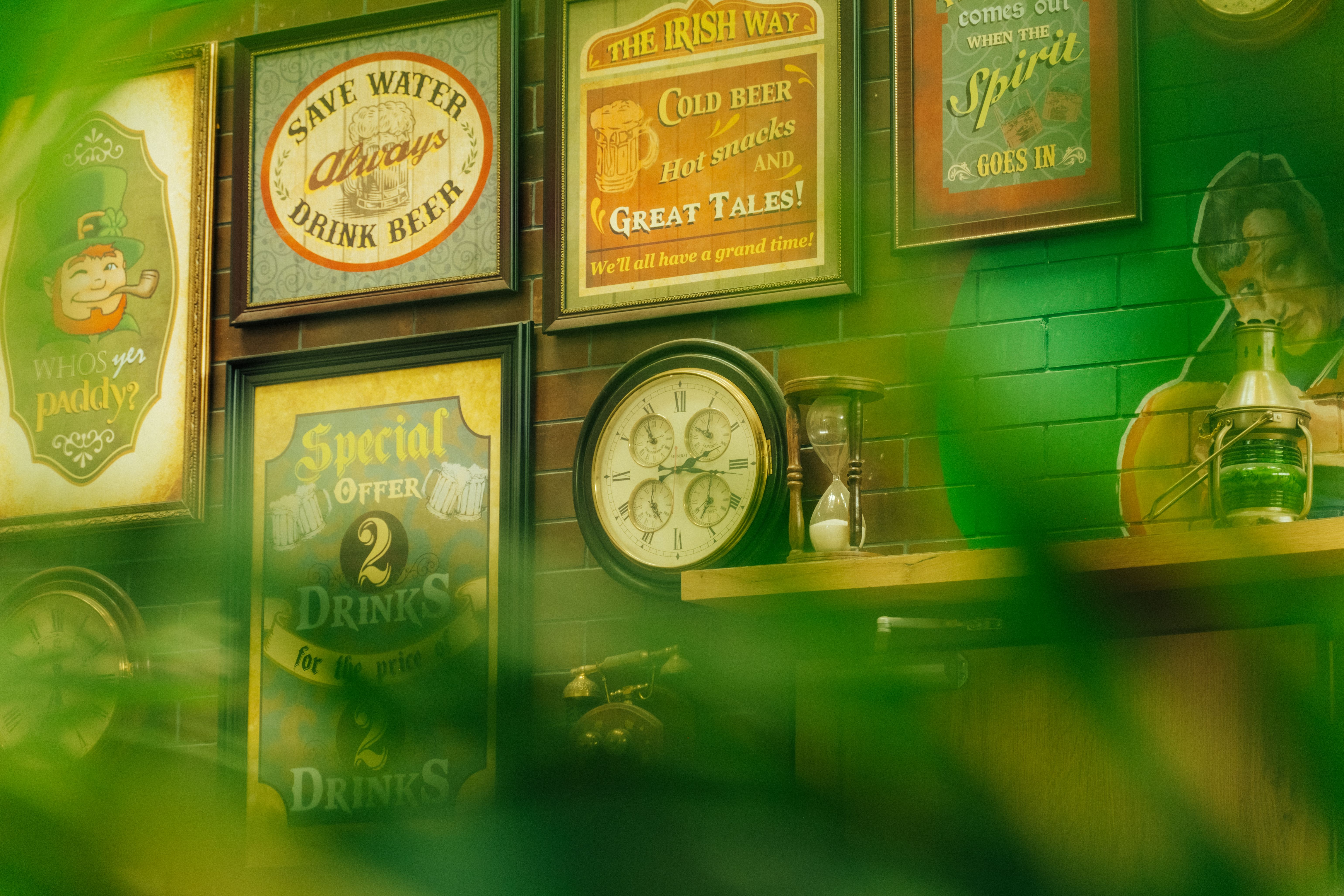 Vintage Pub Decor with Retro Posters and Clock · Free Stock Photo