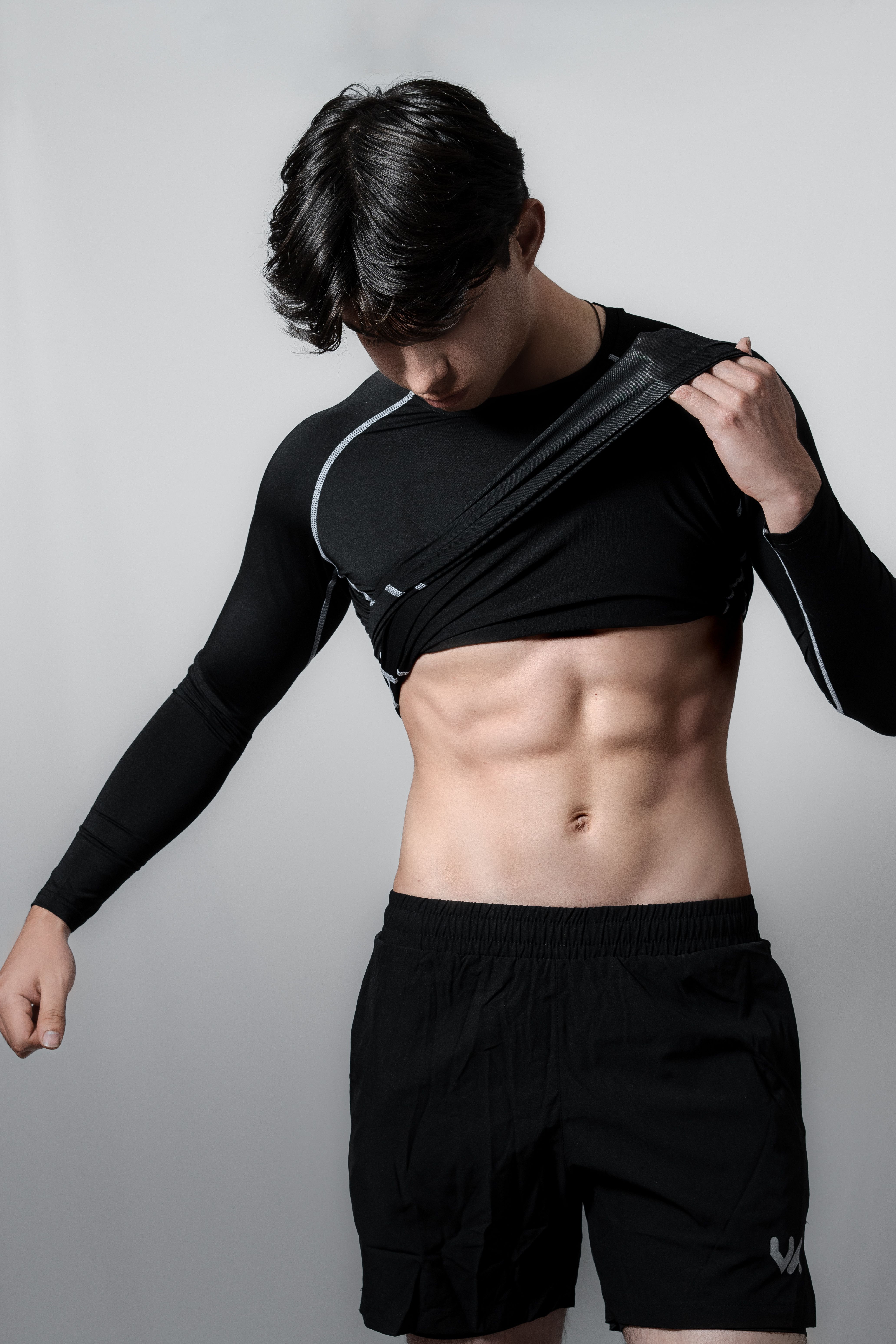Athlete Showing Defined Abs in Black Sportswear · Free Stock Photo