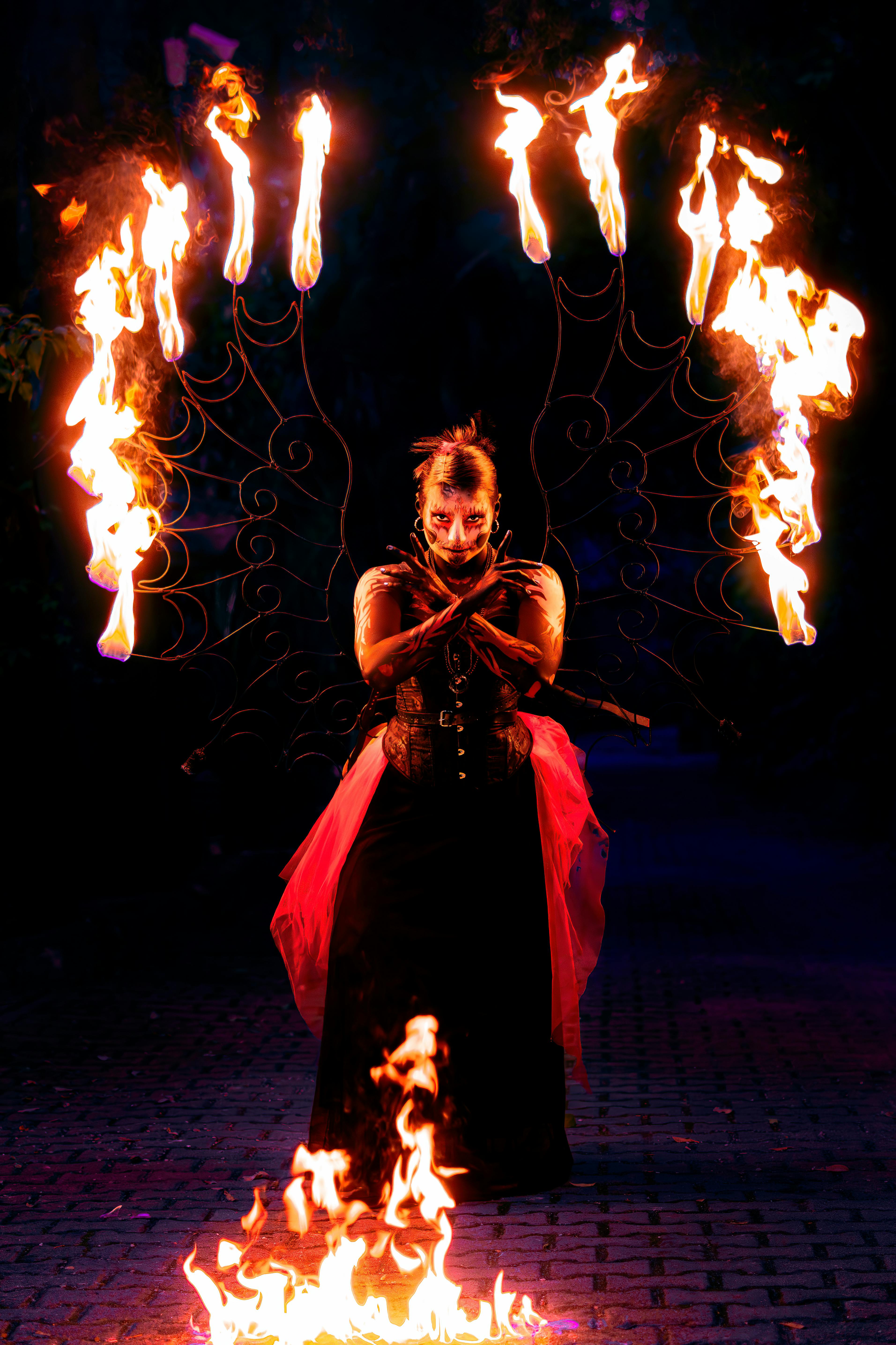 Dramatic Fire Performer with Flaming Wings · Free Stock Photo