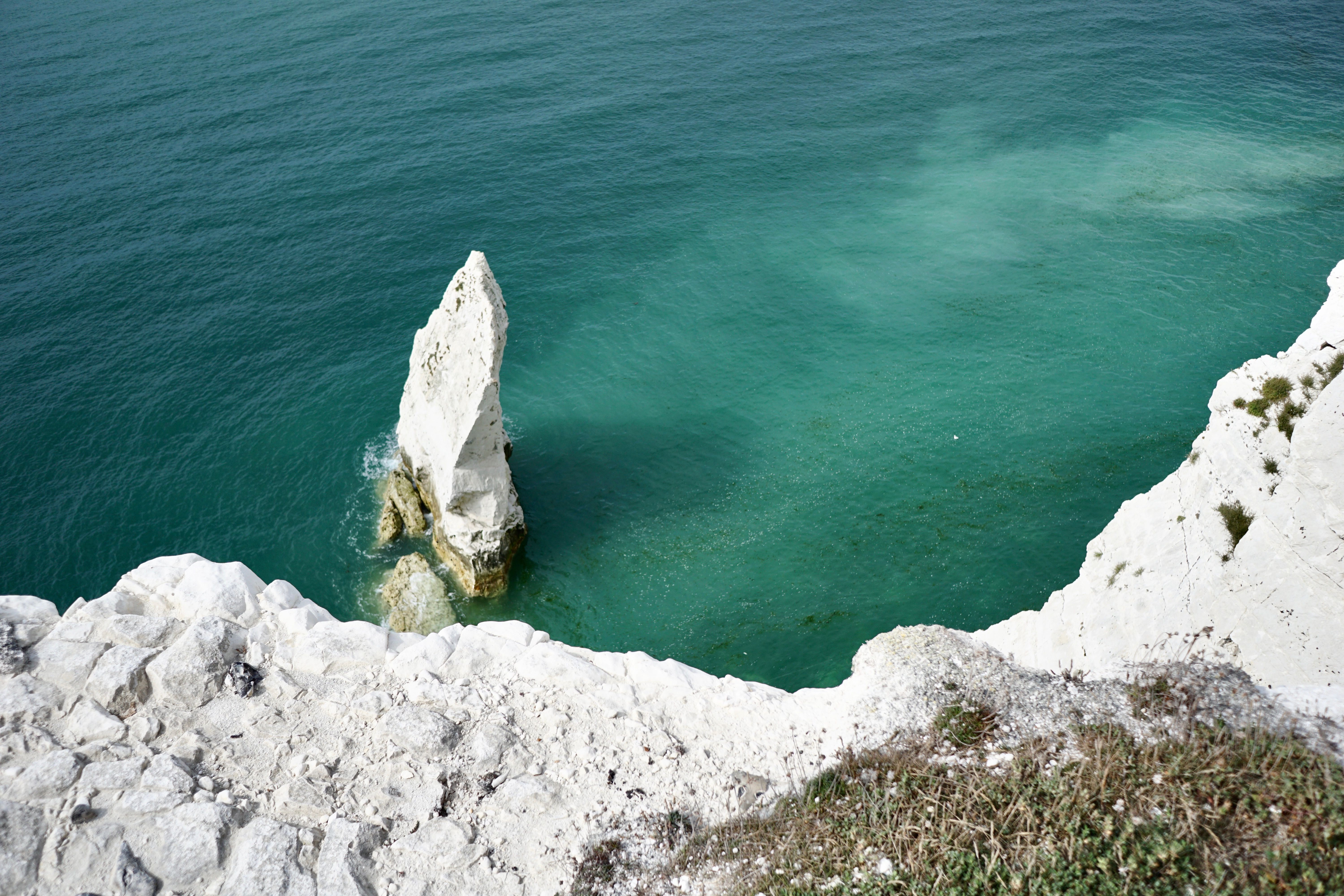 Dramatic Coastal Cliff with Turquoise Sea · Free Stock Photo