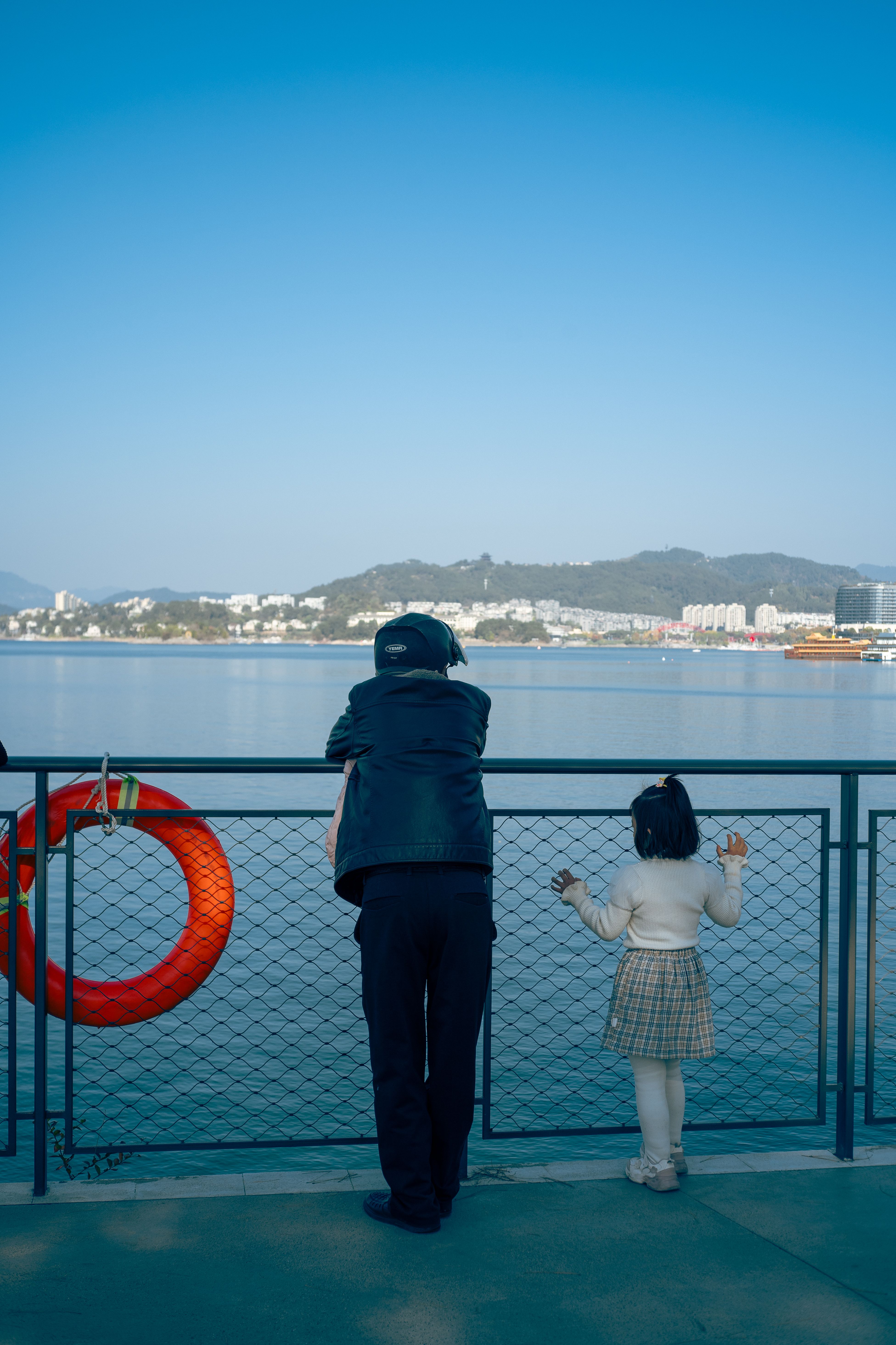 Father and Child Enjoy Scenic Lake View · Free Stock Photo