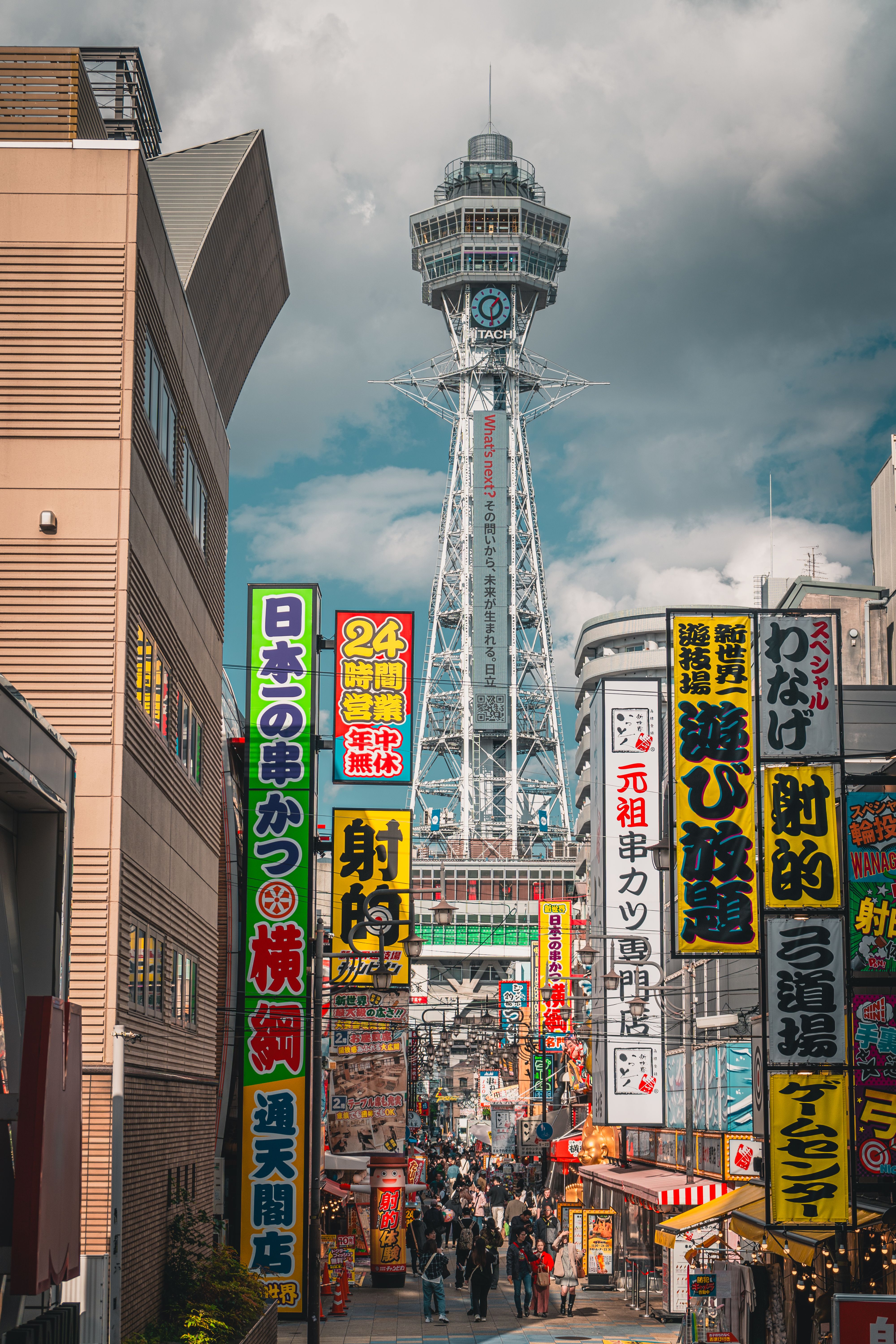 Vibrant Street Scene in Osaka with Tsutenkaku Tower · Free Stock Photo