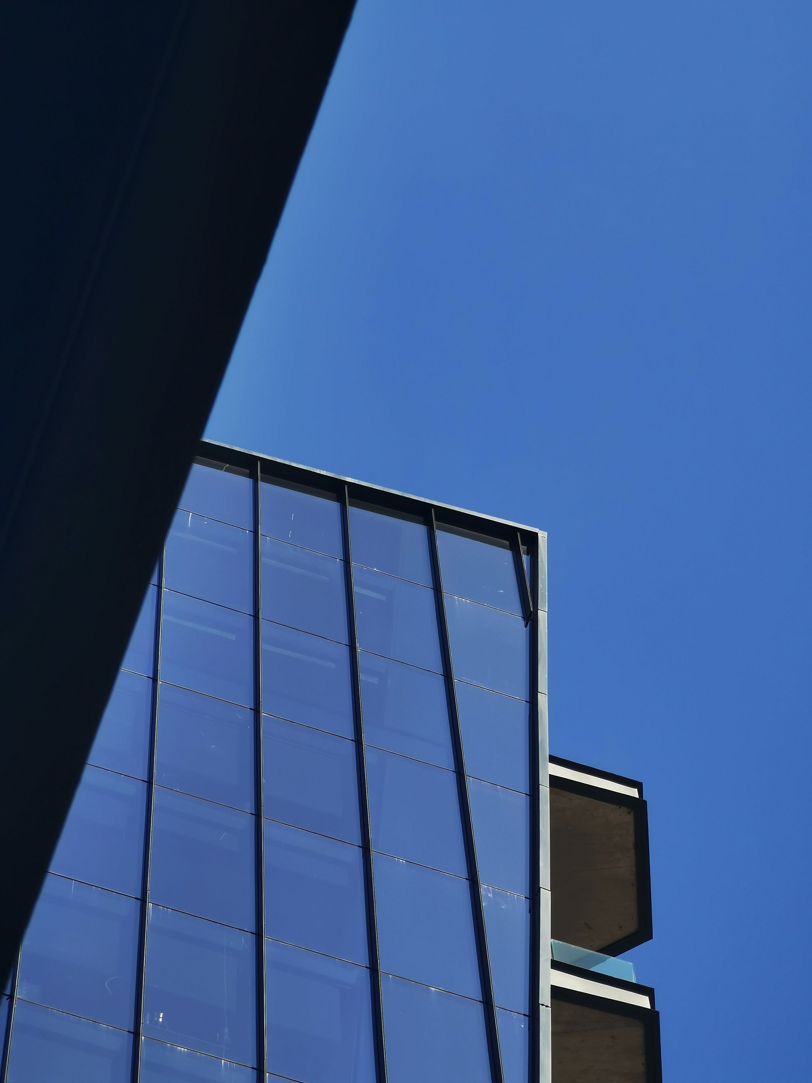 Modern Glass Building Against Blue Sky · Free Stock Photo